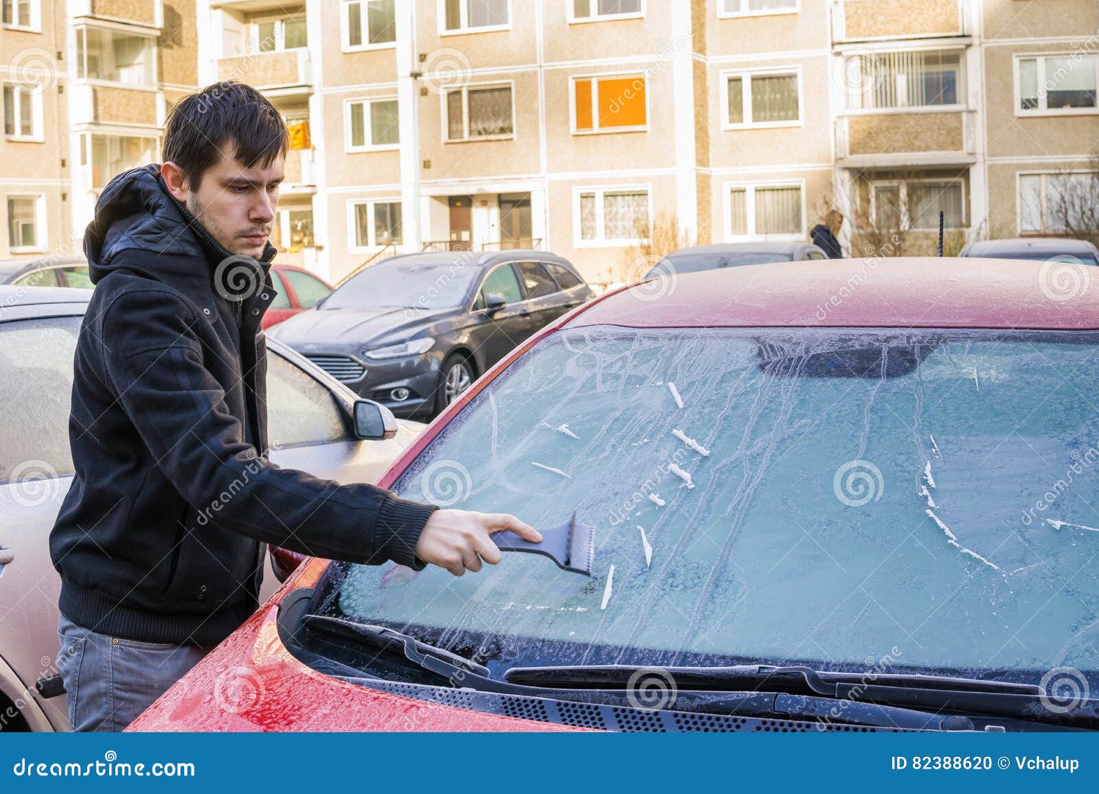 Man is Scraping Ice from Frozen Windshield Window of Car in Winter ...