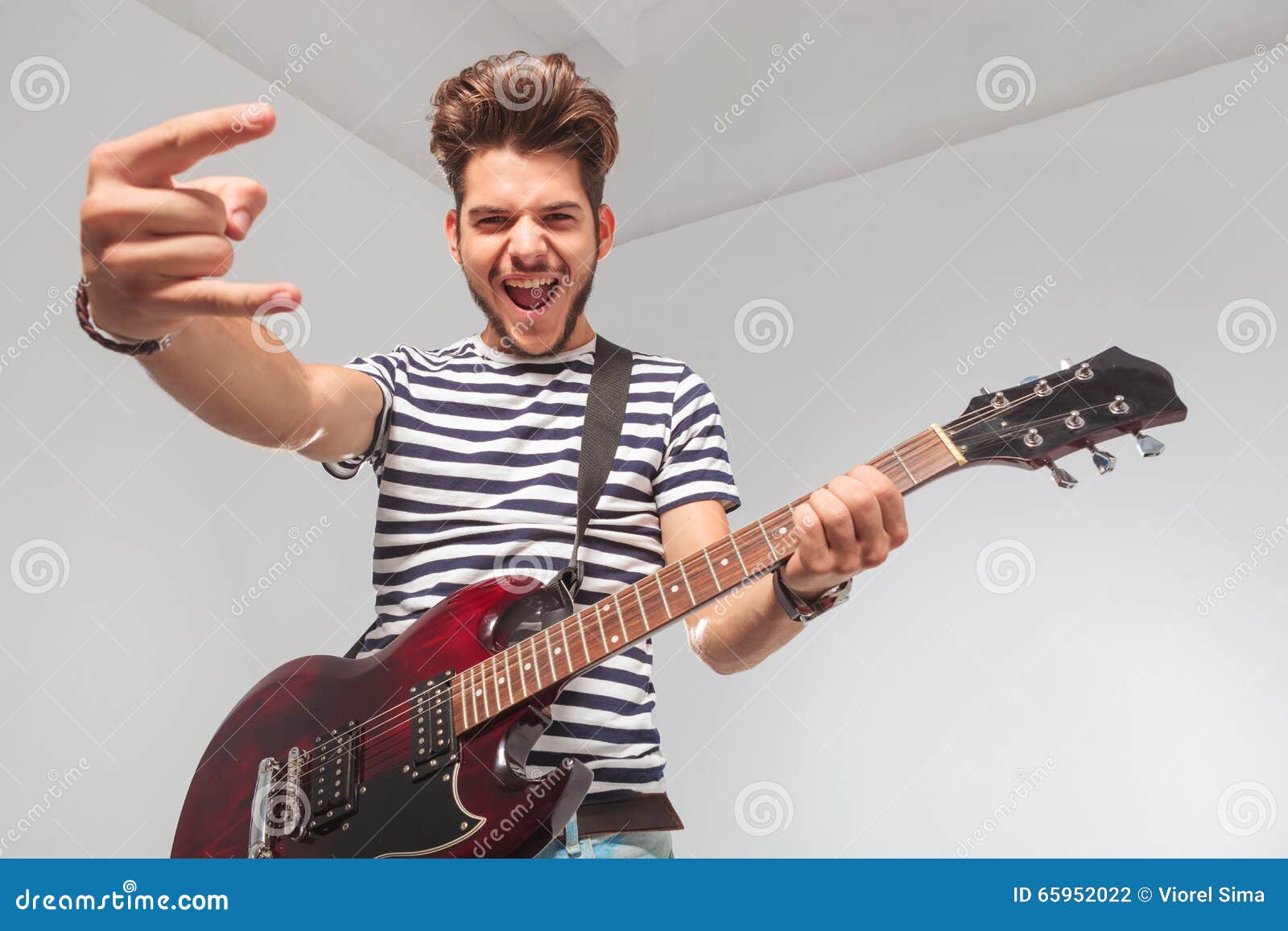 Man Screaming while Playing Guitar and Looking Down Stock Photo - Image ...