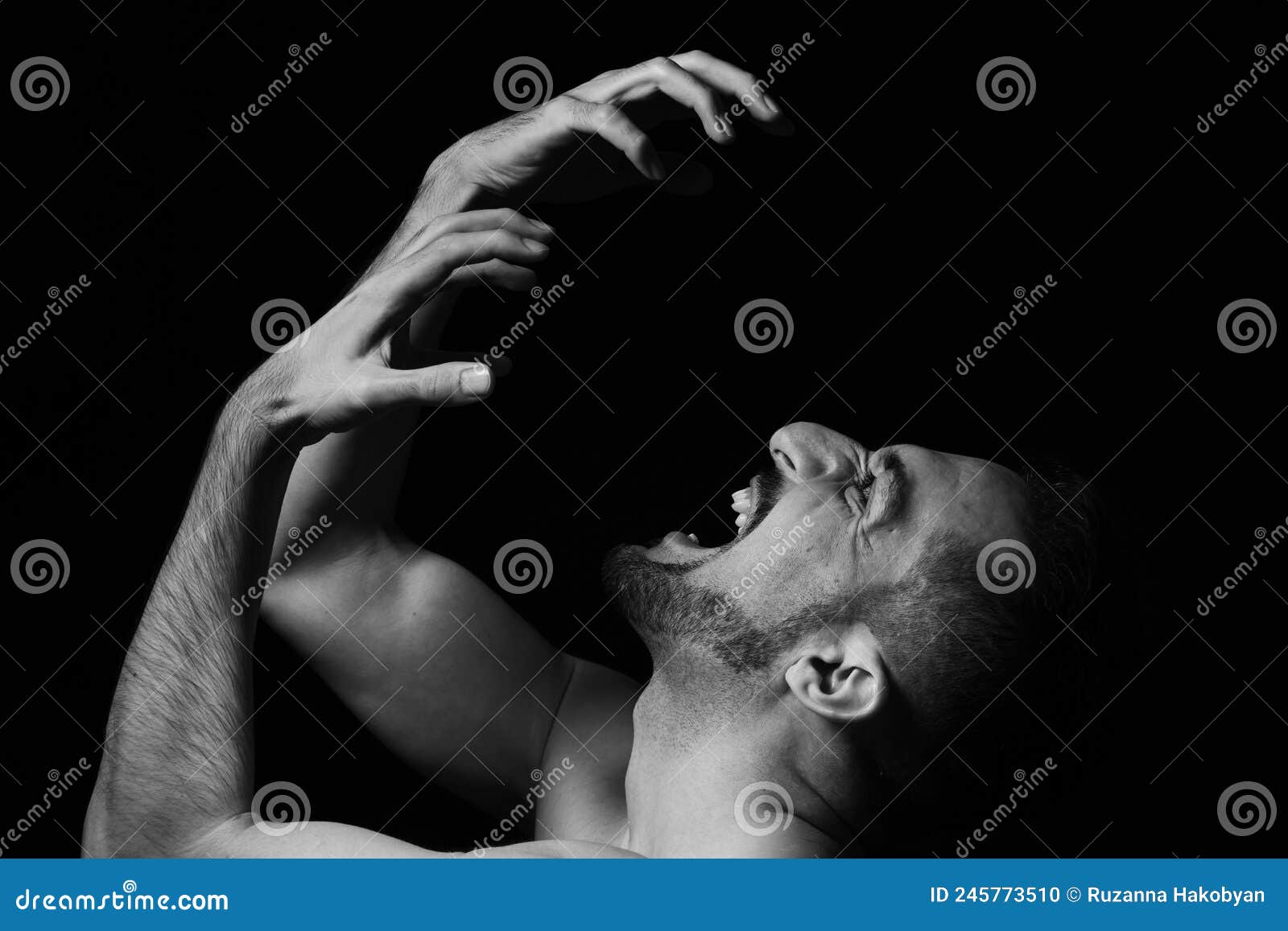A Man Screams in Rage on a Black Background. a Clear Display of Emotion ...