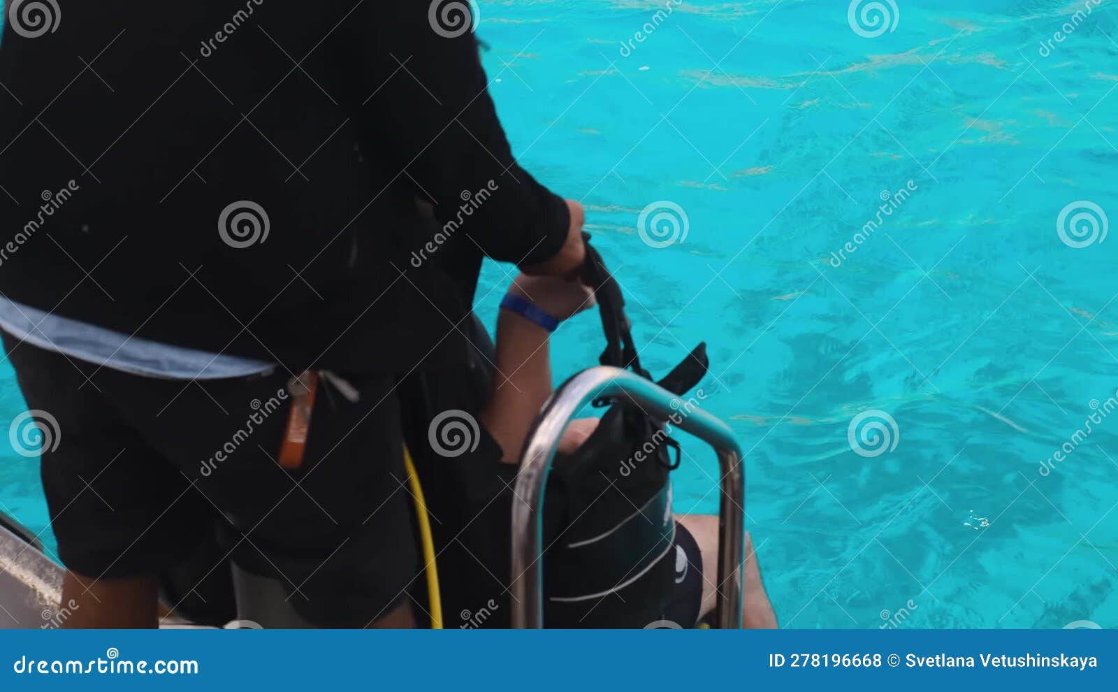 A Man with Scuba Diving is Sitting on Board a Yacht, Preparing To Dive ...