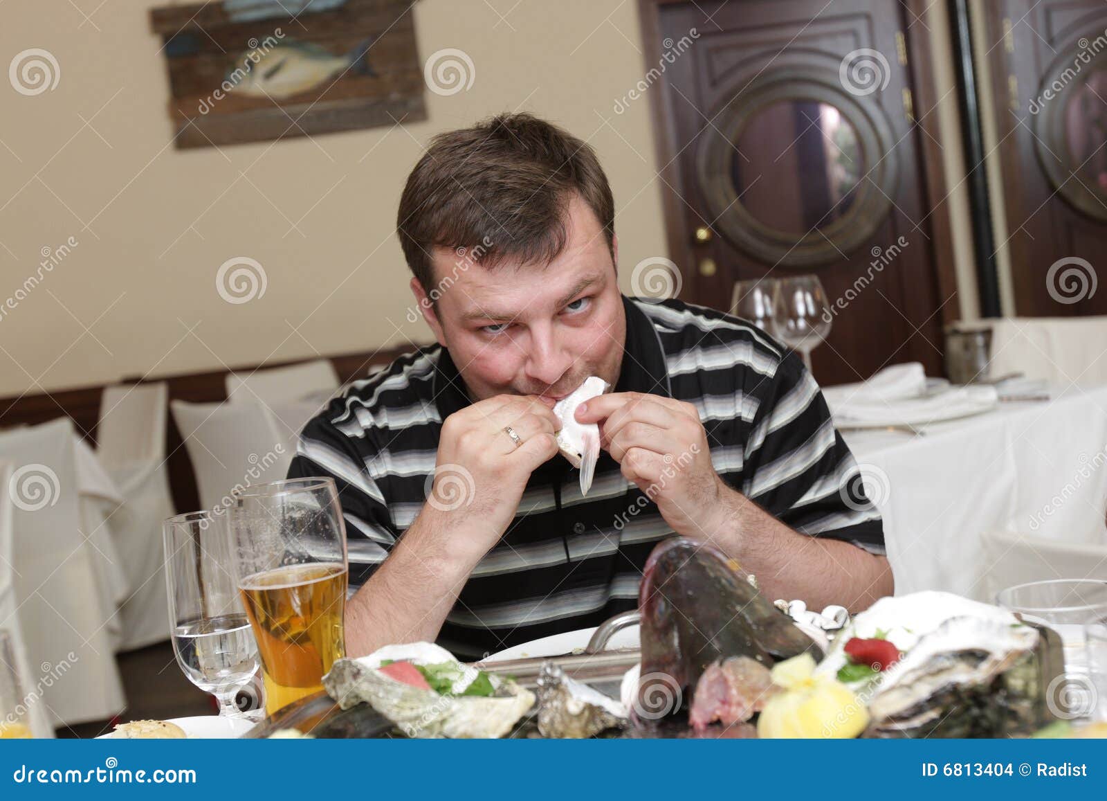 Man in seafood restaurant stock photo. Image of utensil - 6813404