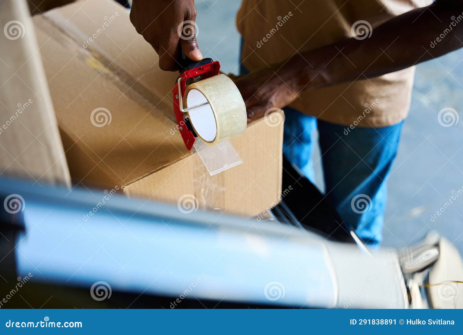 Man Seals a Cardboard Box with Tape Stock Image - Image of cells ...