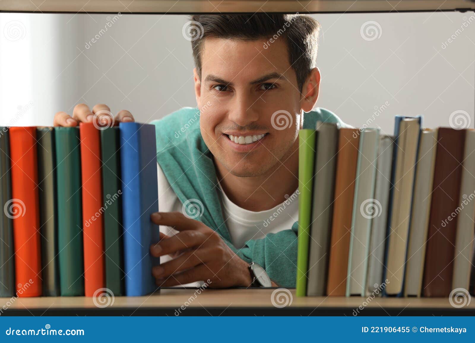 Man Searching for Book on Shelf in Library Stock Image - Image of ...