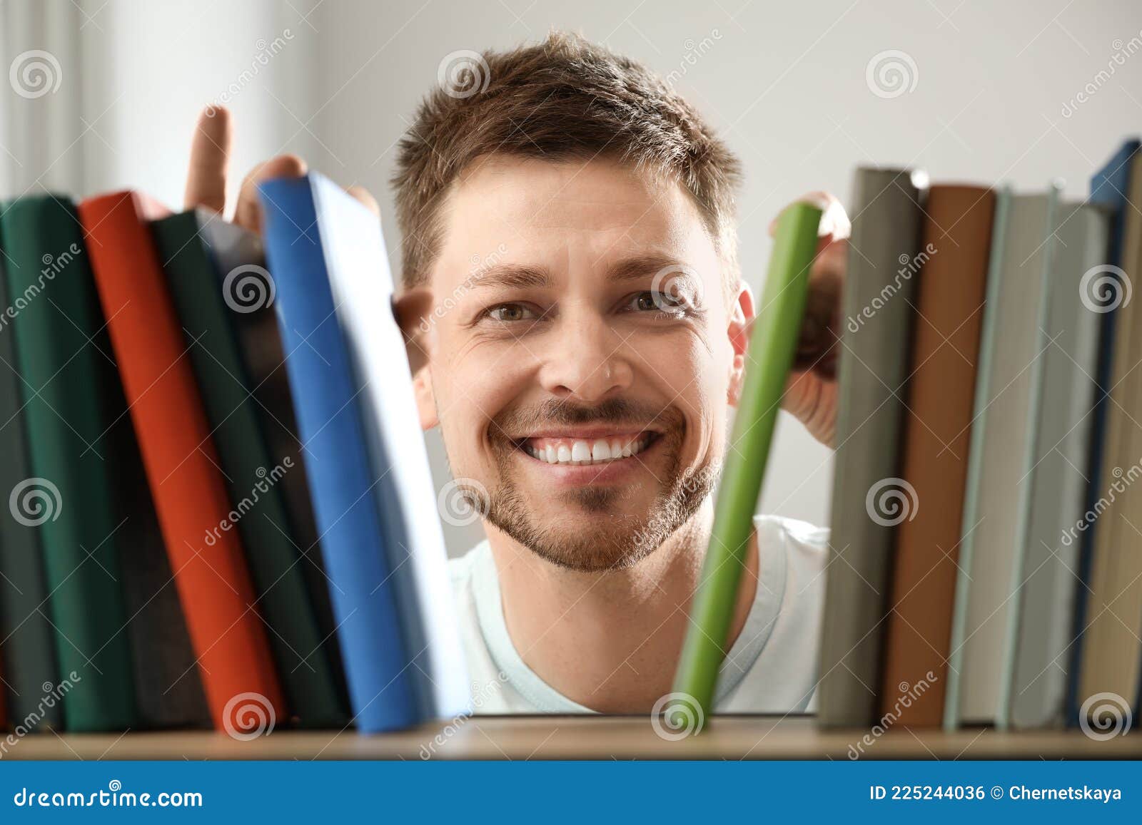 Man Searching for Book on Shelf in Library Stock Photo - Image of ...