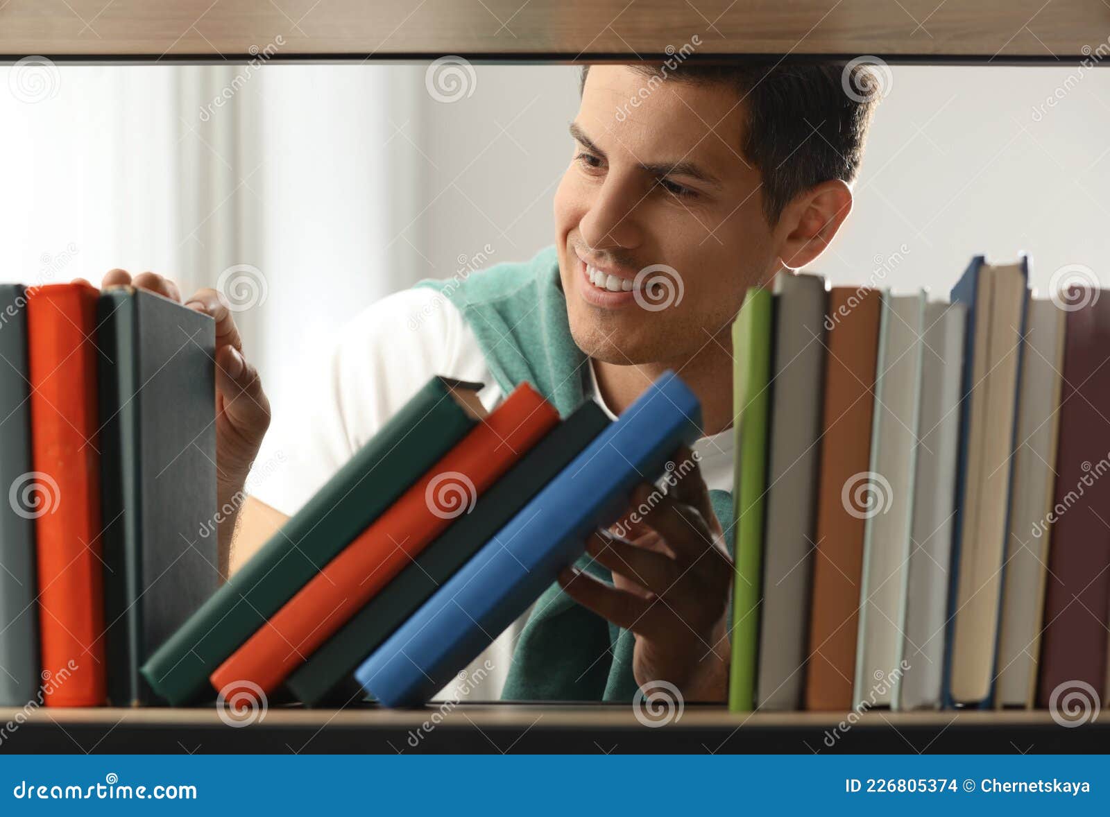 Man Searching for Book on Shelf in Library Stock Photo - Image of books ...