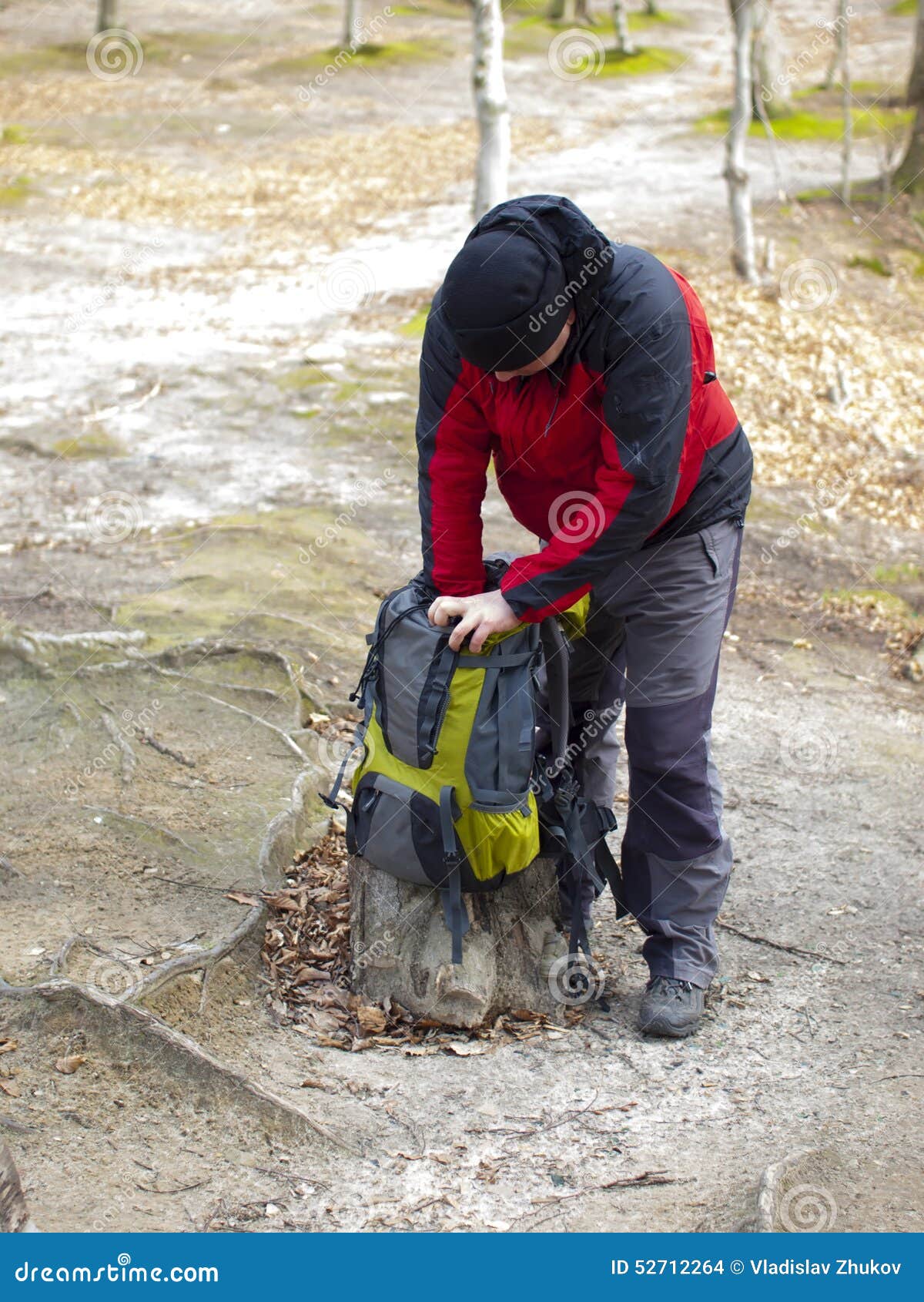 A Man Searching for Something in His Backpack. Stock Photo - Image of ...