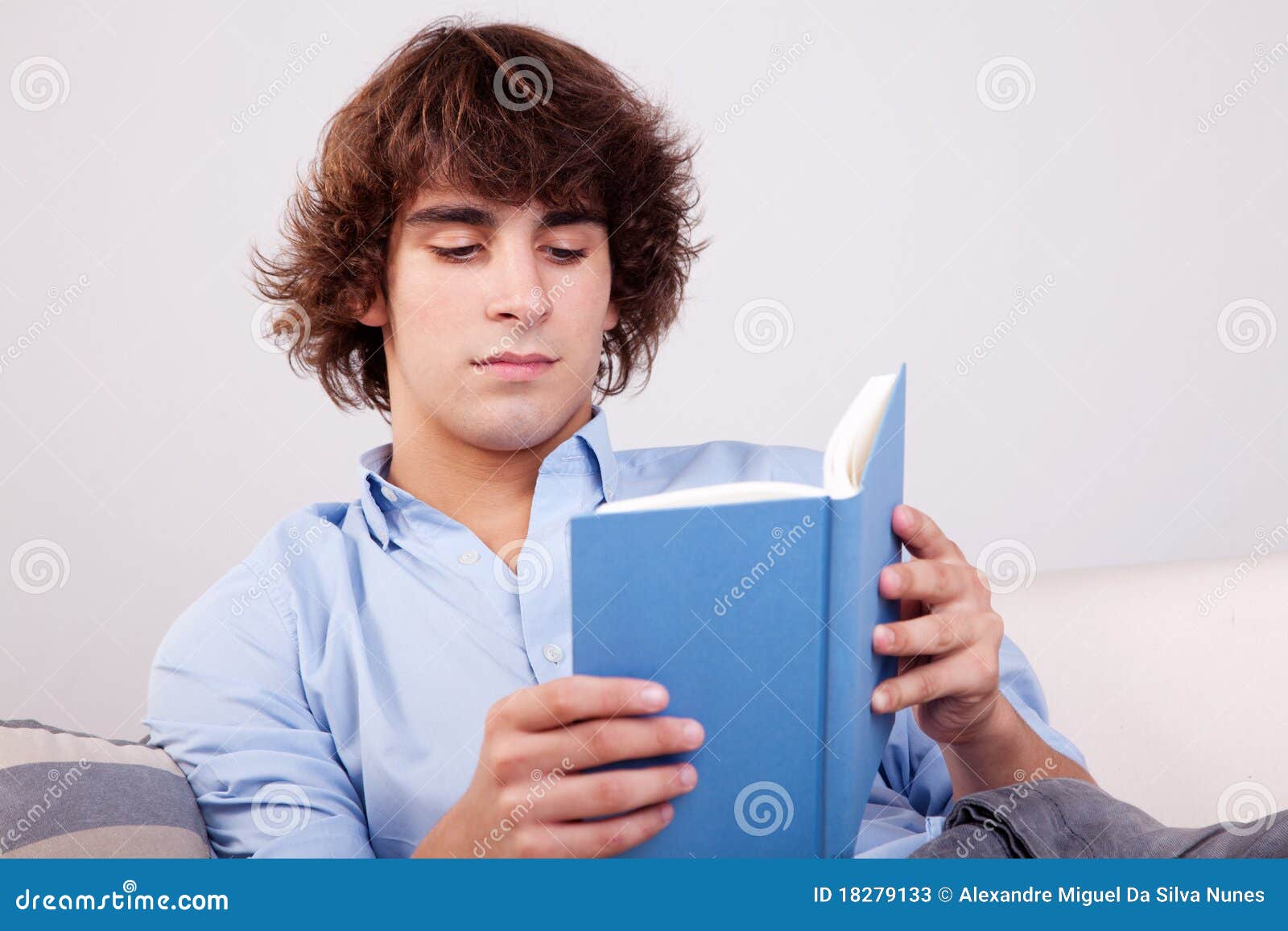 Man seated reading a book stock image. Image of human - 18279133