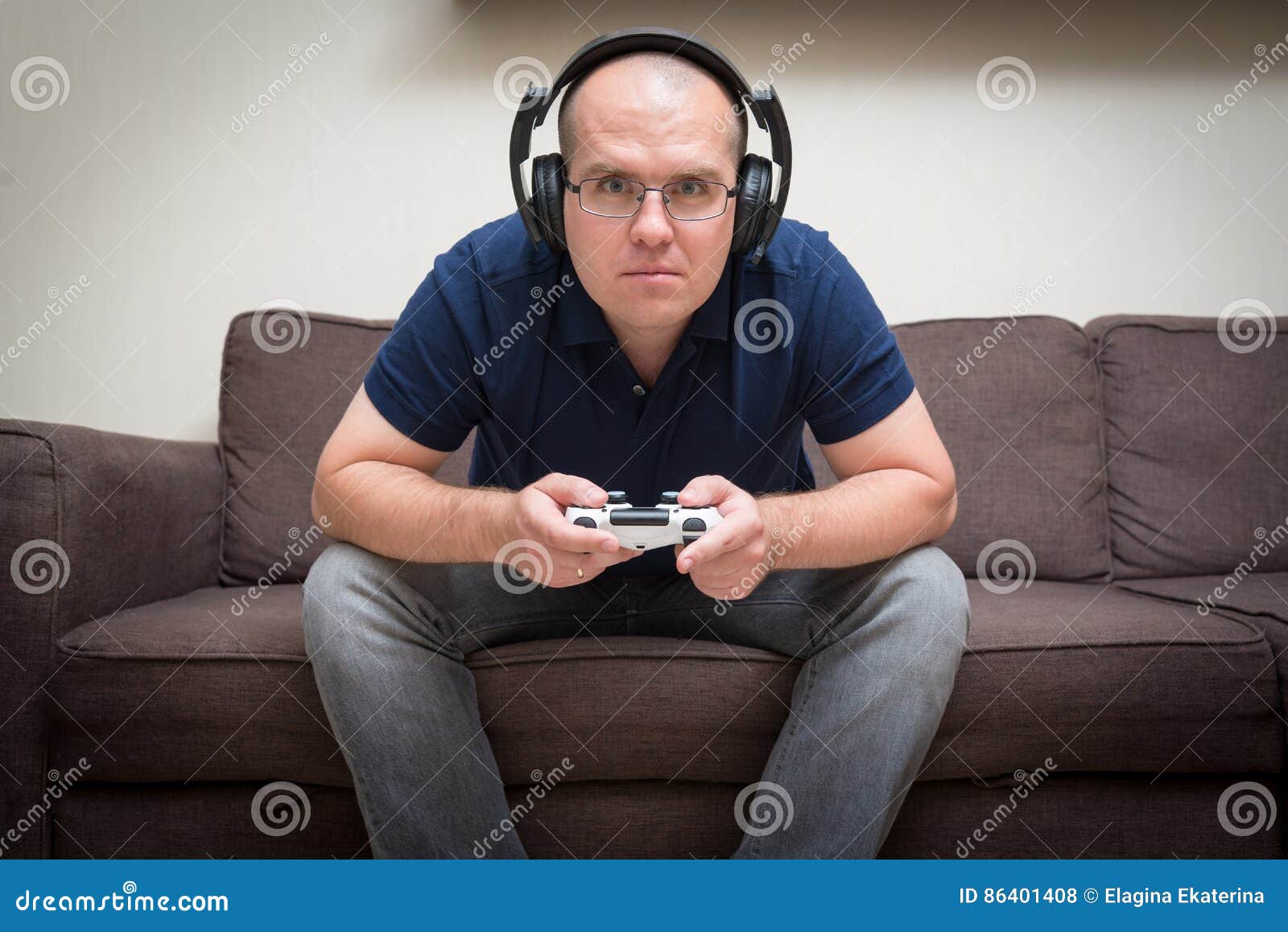 Man Seated on a Sofa with Console Controller in Hands and Playin Stock ...