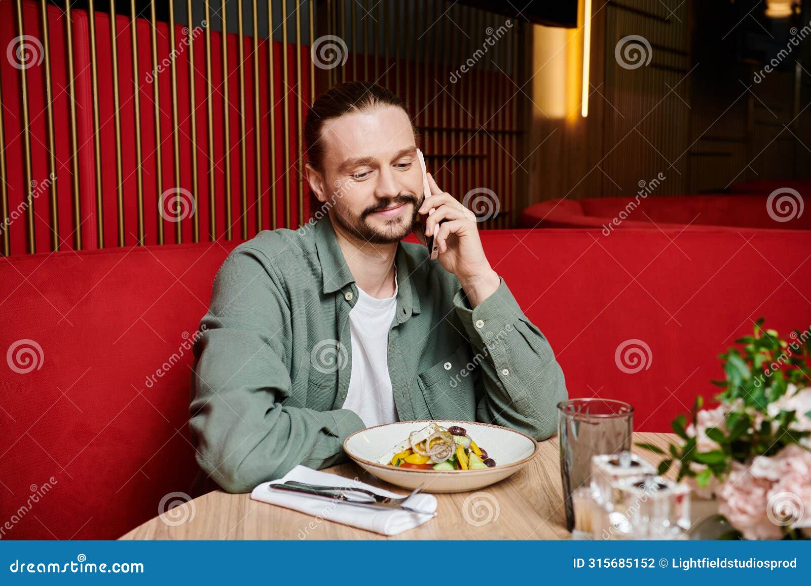A man, seated at a table stock photo. Image of smartphone - 315685152