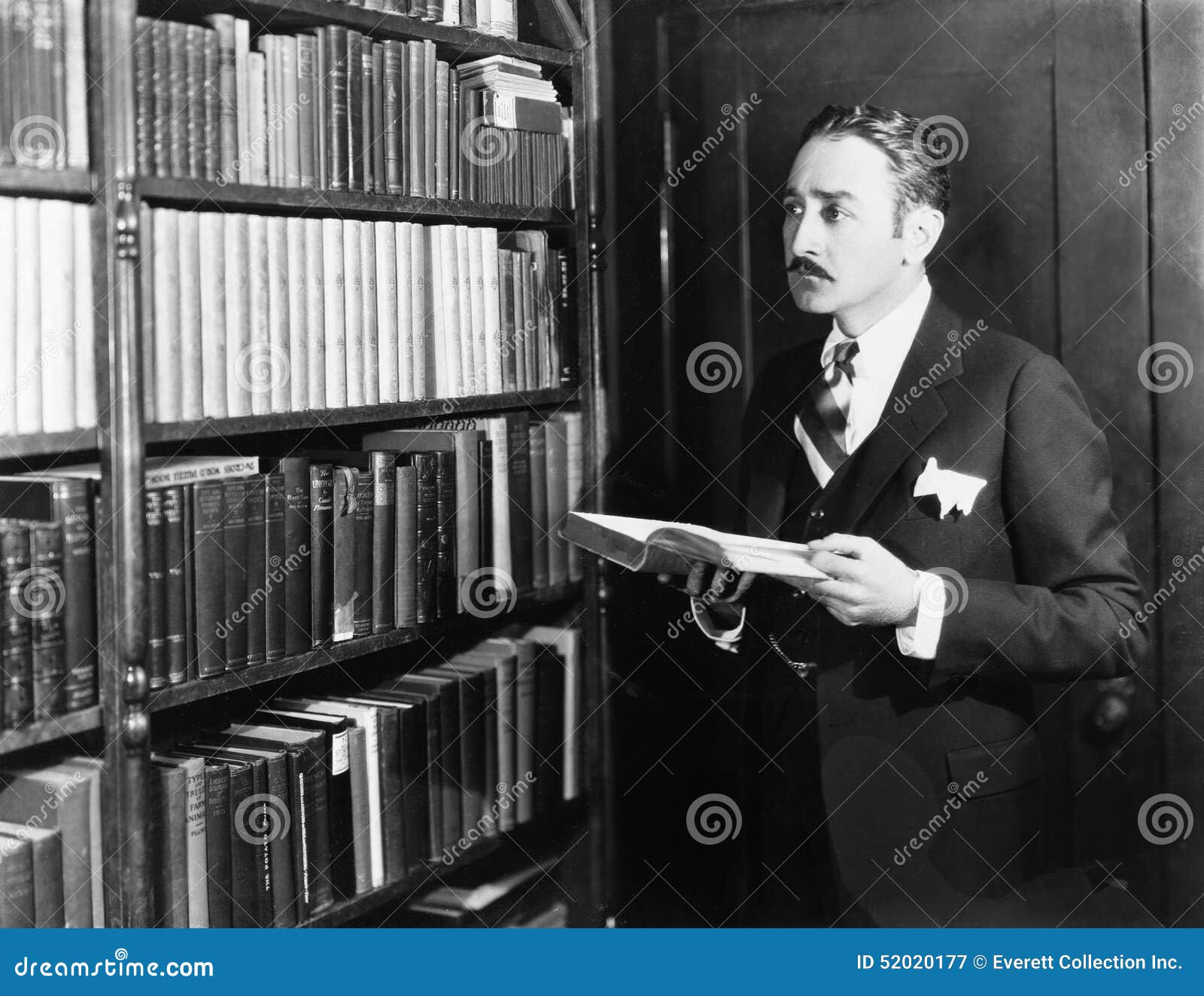 Man Selecting Books from Bookshelf in a Library Stock Image - Image of ...