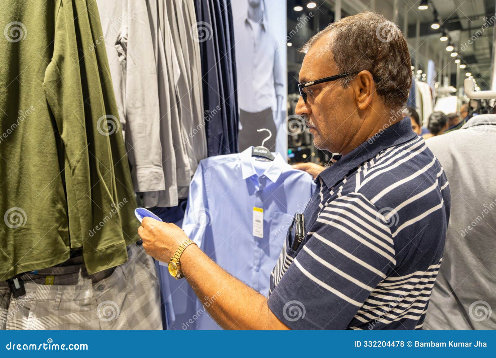 Man Selecting Clothes at Indoor Shopping Mall Stock Photo - Image of ...