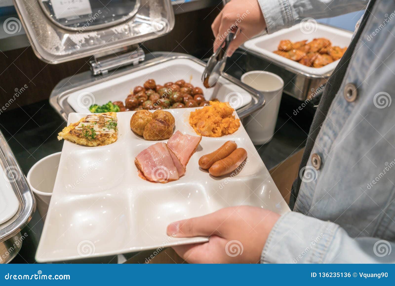 Man Selecting His Meal from a Breakfast Buffet Stock Photo - Image of ...