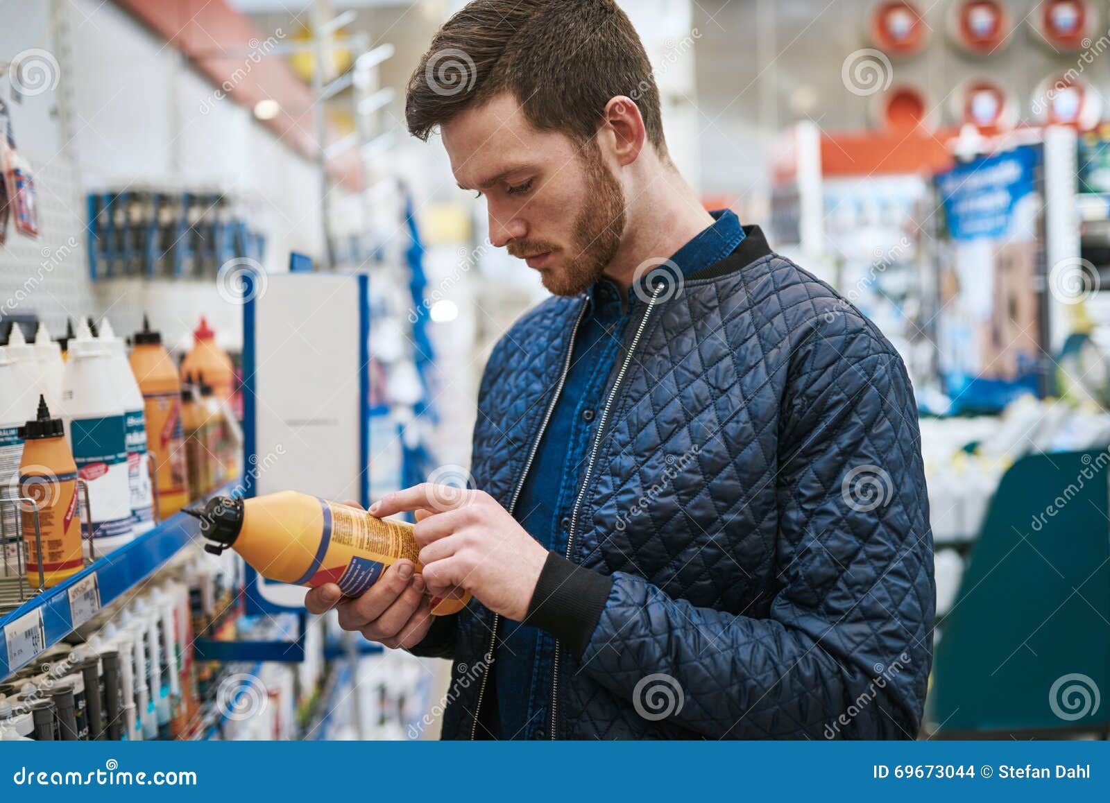 Man Selecting a Product in a Hardware Store Stock Photo - Image of ...