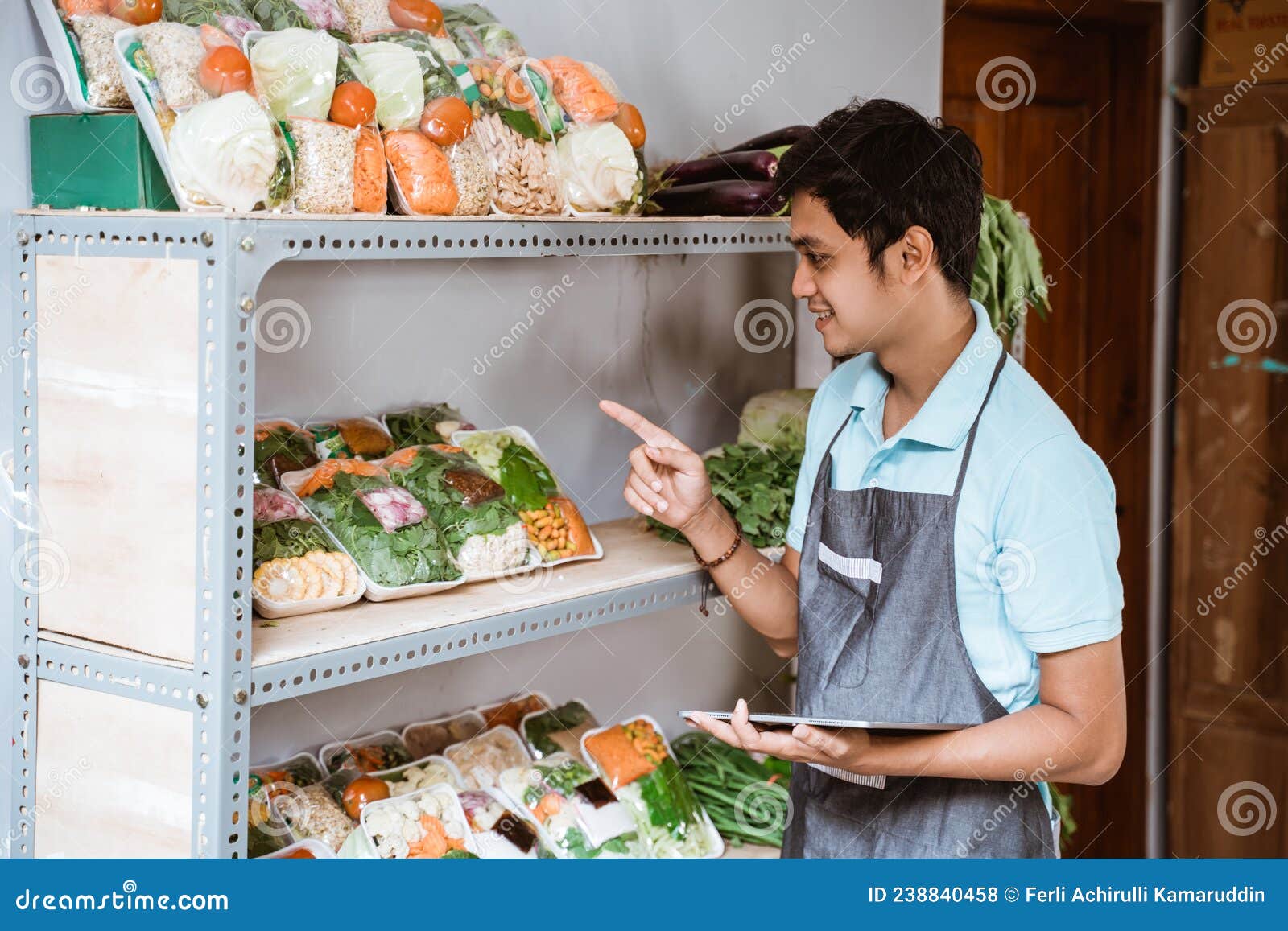 Man Selling Vegetables Counting Vegetables Using a Digital Tablet Stock ...