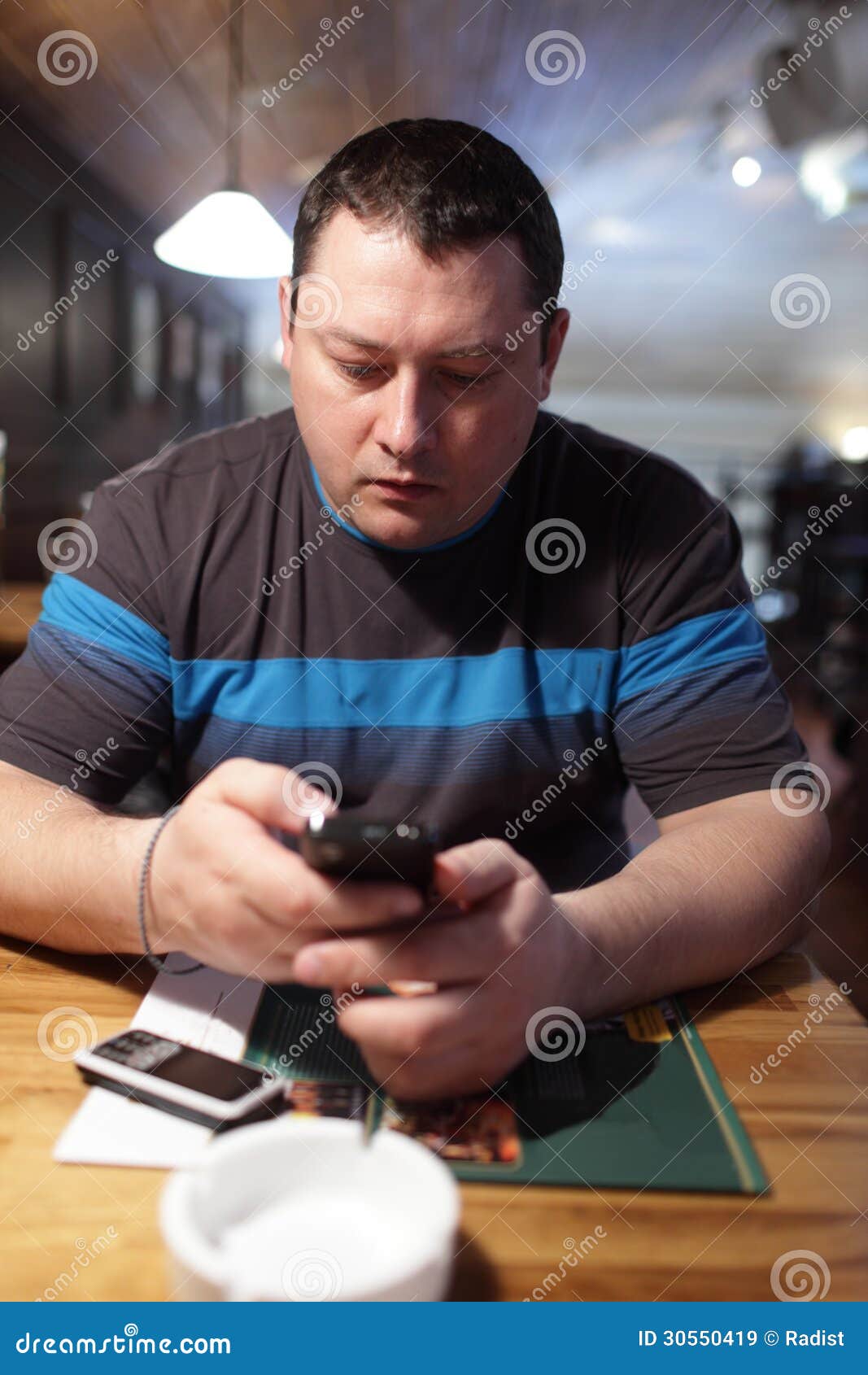 Man sending email in a pub stock image. Image of activity - 30550419