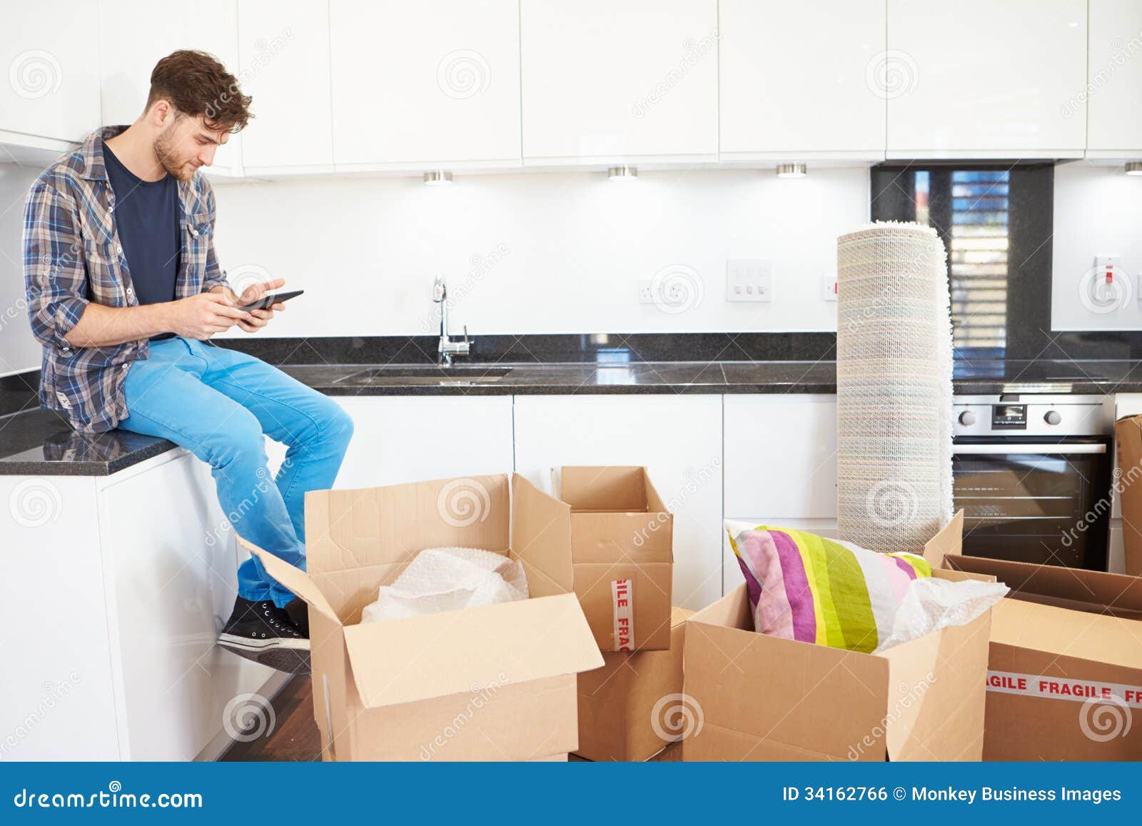 Man Sending Text Message Having Moved into New Home Stock Photo - Image ...
