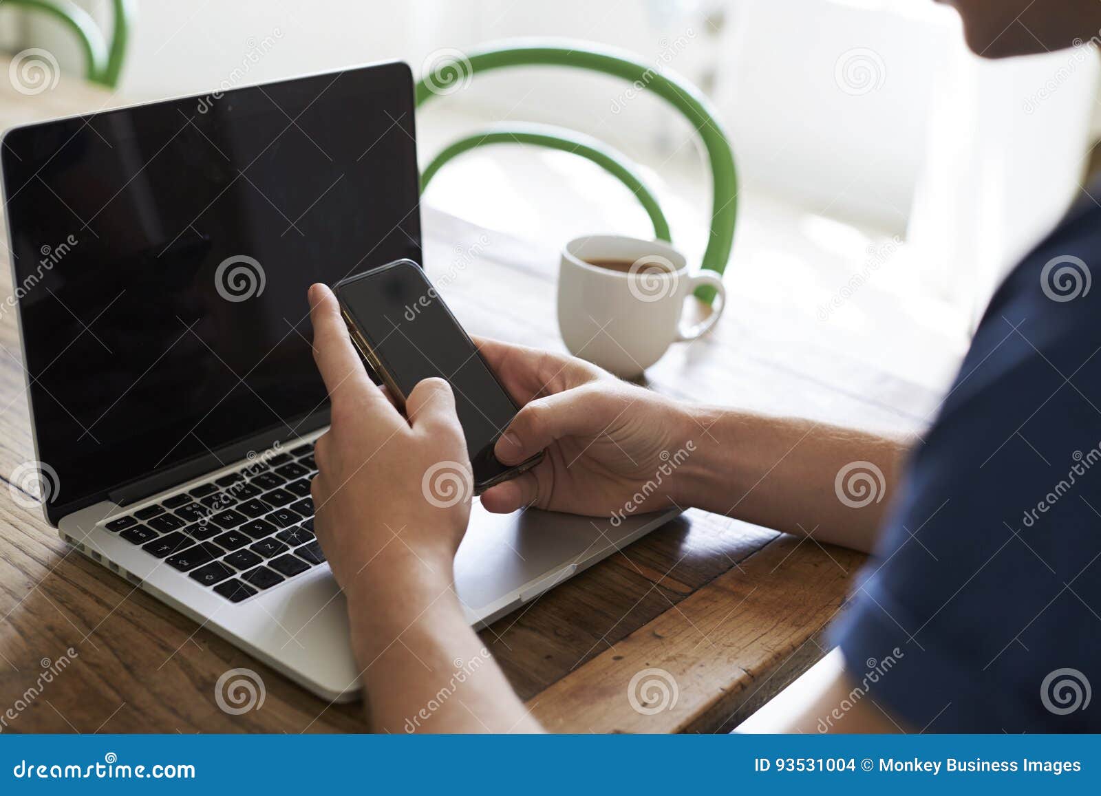 Man Sending Text Message on Mobile Phone Whilst Using Laptop Stock ...