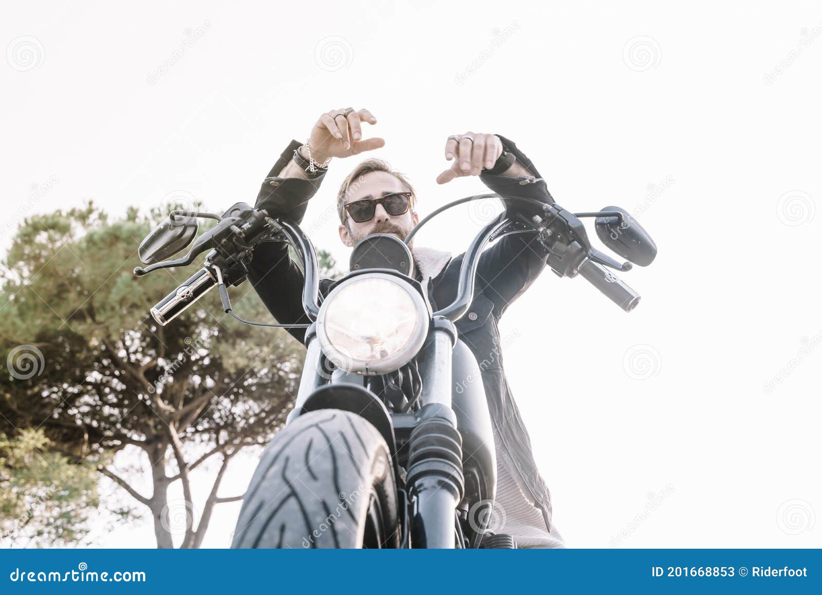 Man with Serious Expression Wearing Sunglasses and Leaning Against the ...