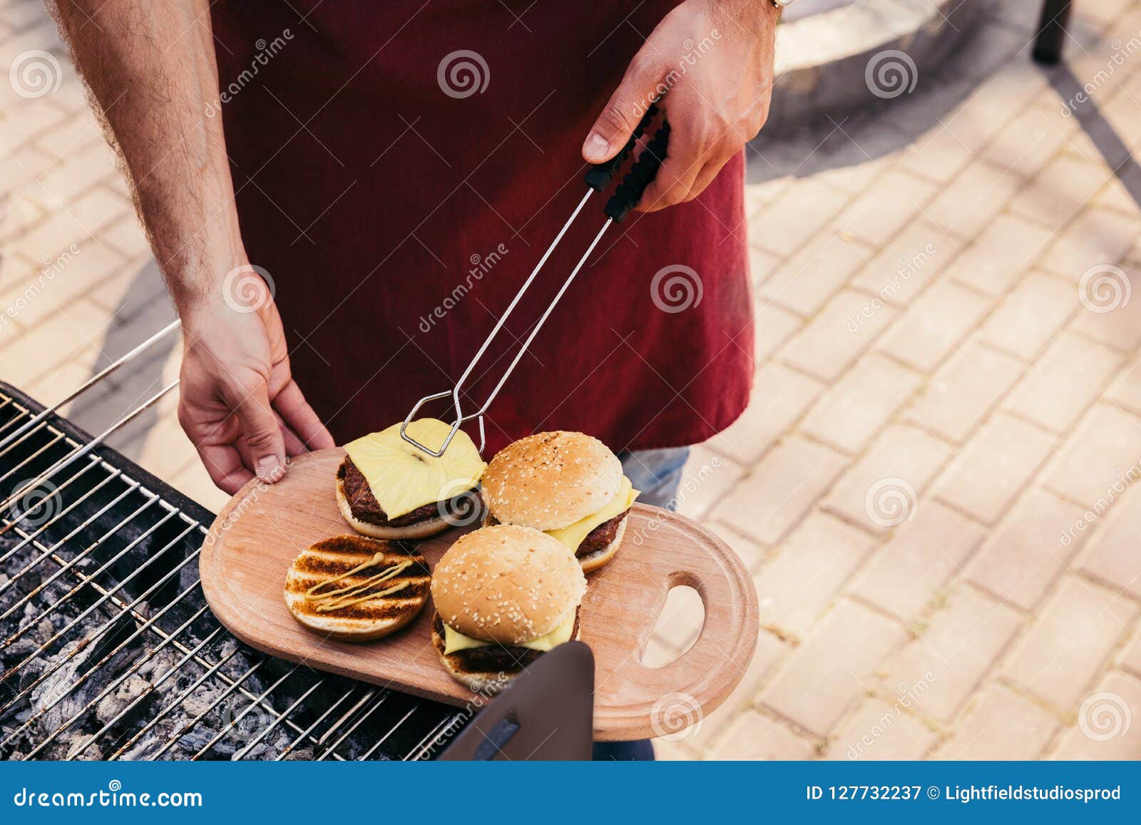 Man Serving Hamburgers Cooked Outdoors on Grill Stock Image - Image of ...