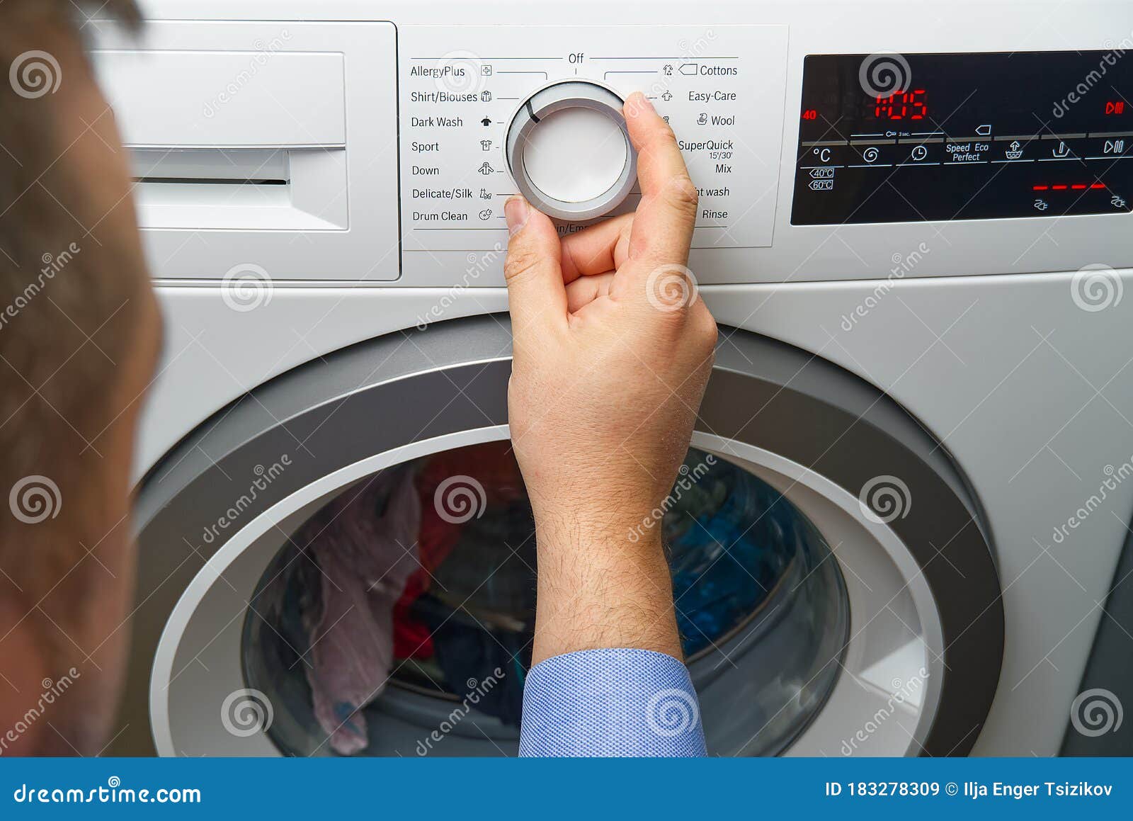 The Man Sets the Program and Turns on the Washing Machine. Close-up of ...