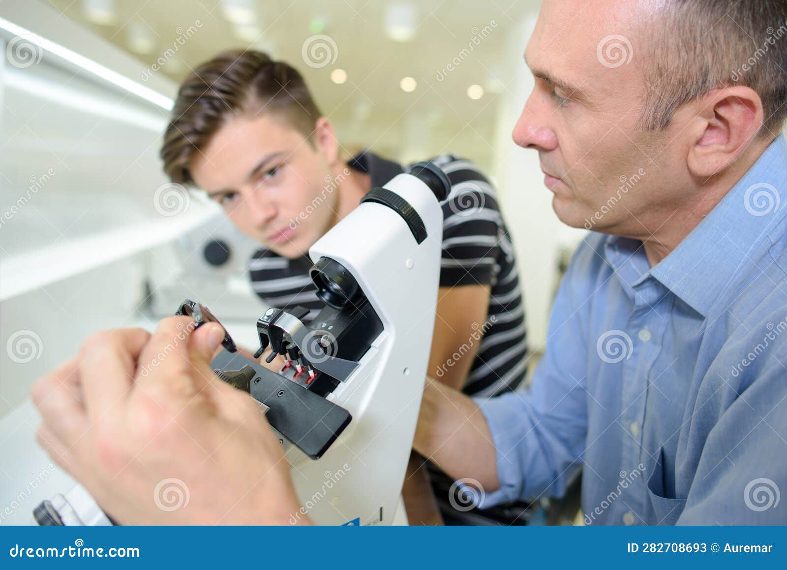 Man Setting Up Microscope Apprentice Watching Stock Image - Image of ...