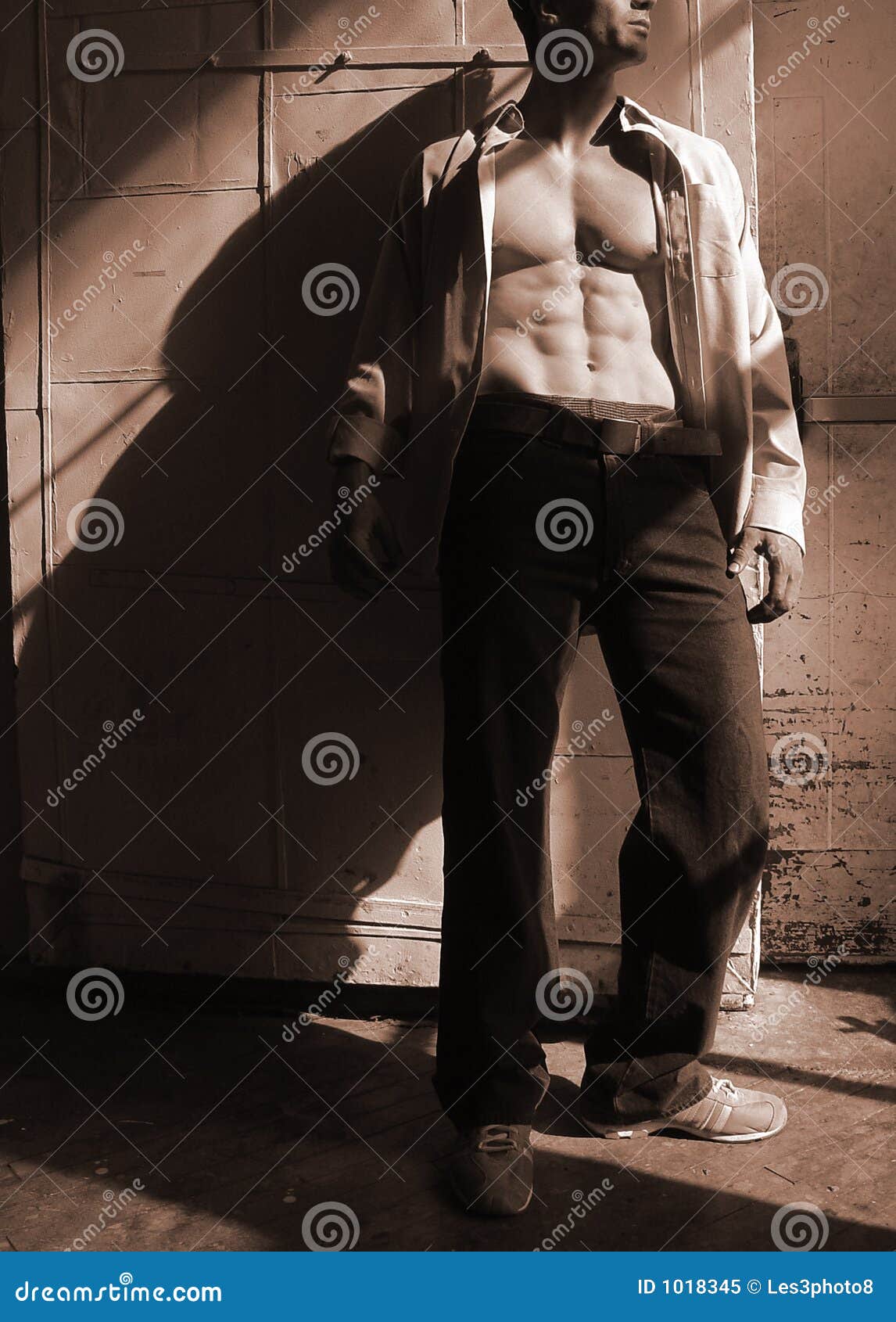 Man in shaft of light stock image. Image of shirtless - 1018345