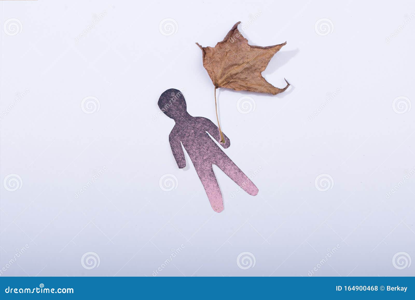 Man Shape Cut Out of Paper on Ground Stock Photo - Image of figurines ...
