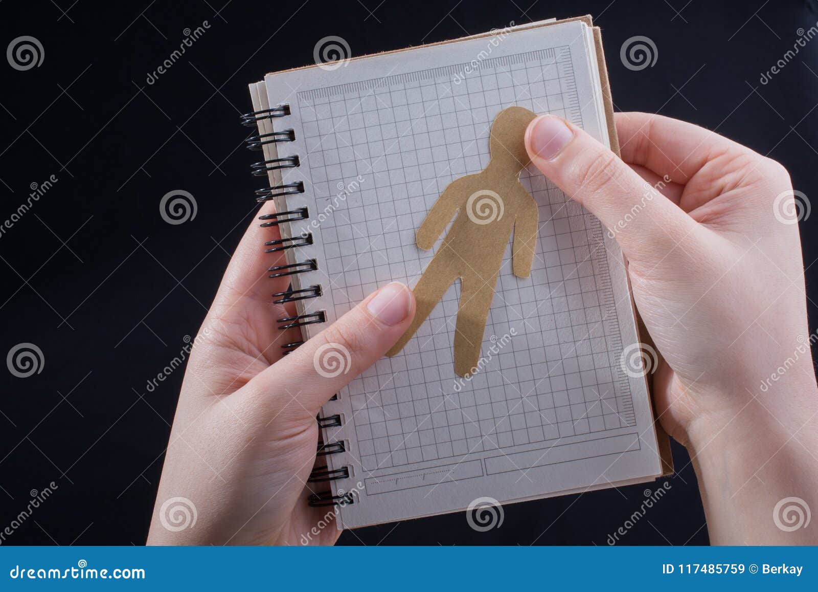 Man Shape Cut Out of Paper in Notebbok Stock Image - Image of holding ...