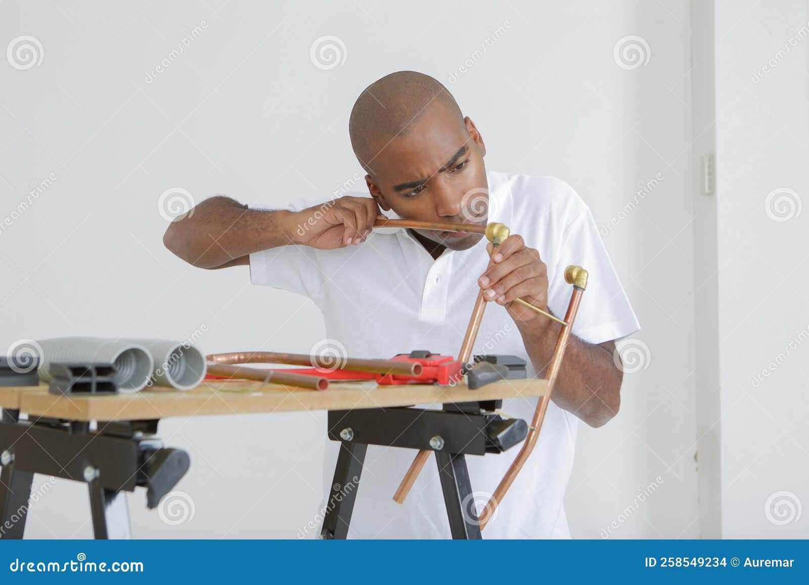 Man shaping copper pipe stock photo. Image of plumbing - 258549234