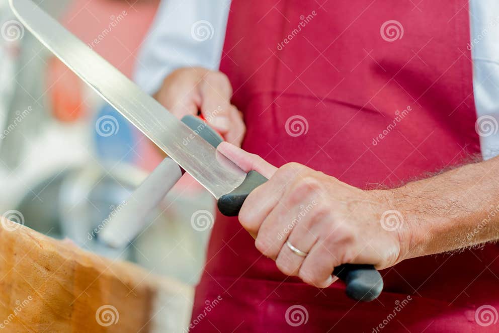 Man sharpening a knife stock photo. Image of skinner - 128022894
