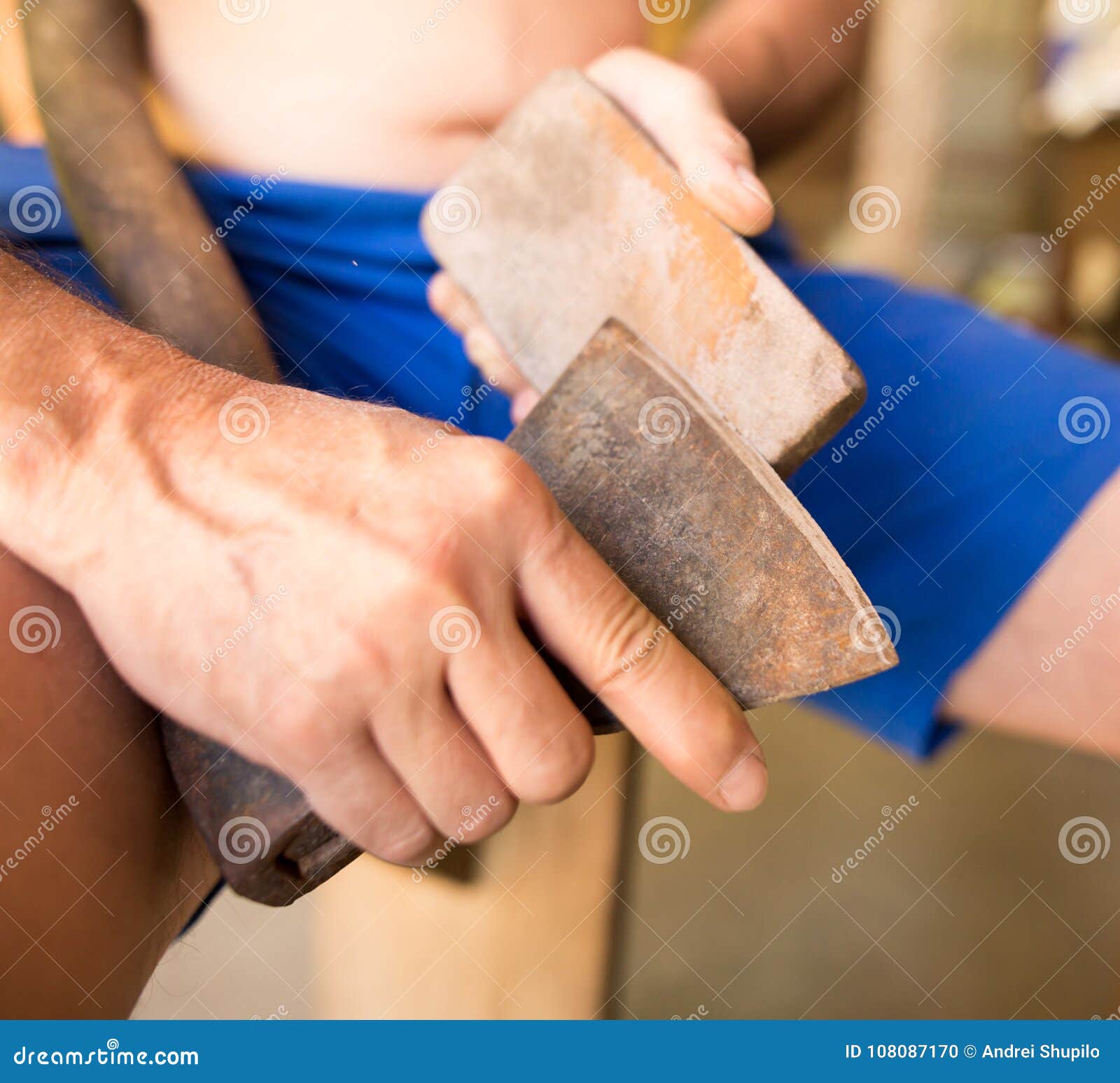 The Man Sharpens an Ax with a Sharpener Stock Photo - Image of ...