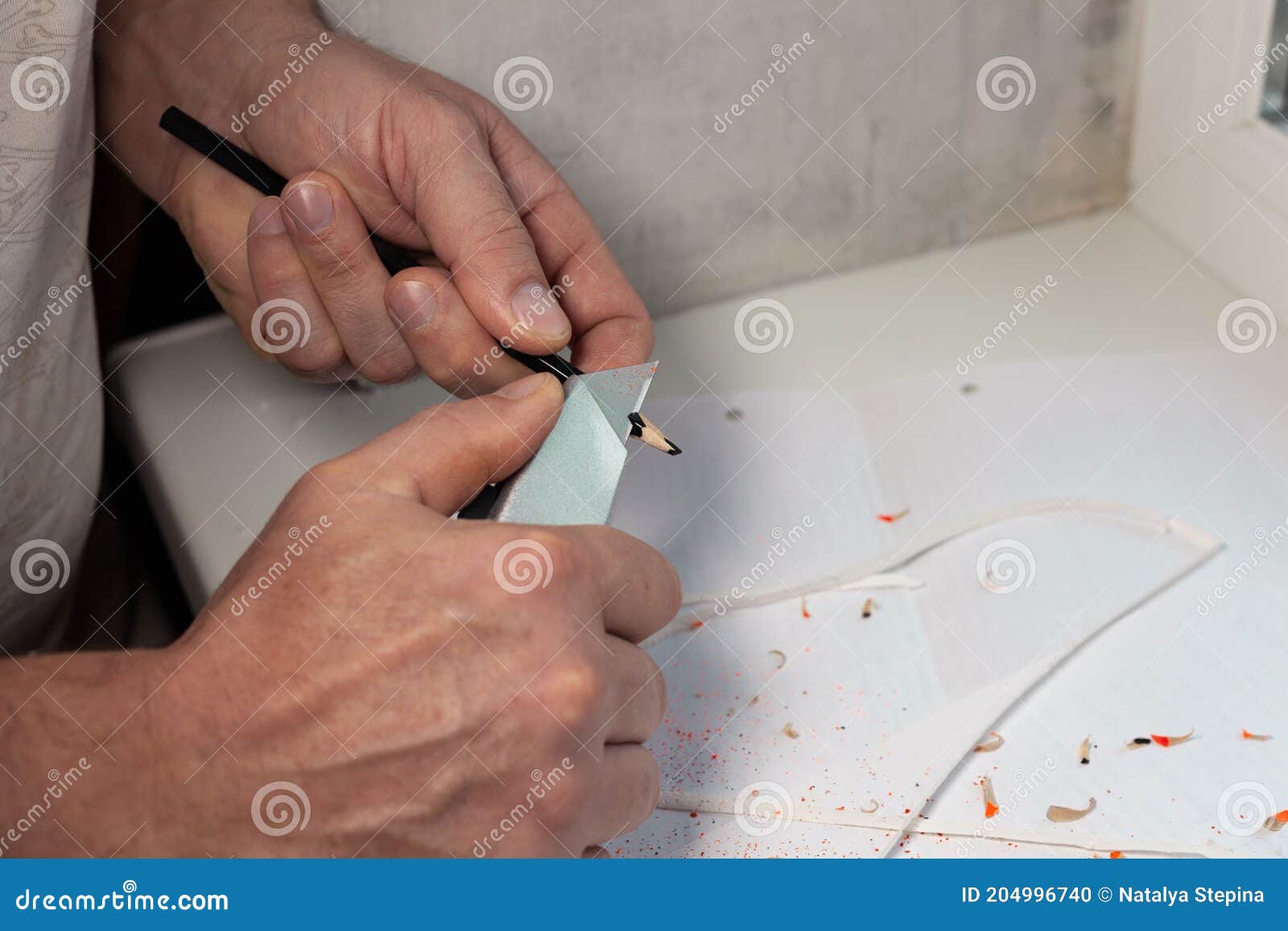 Man Sharpens Black Pencil for Drawing with a Knife Stock Photo - Image ...
