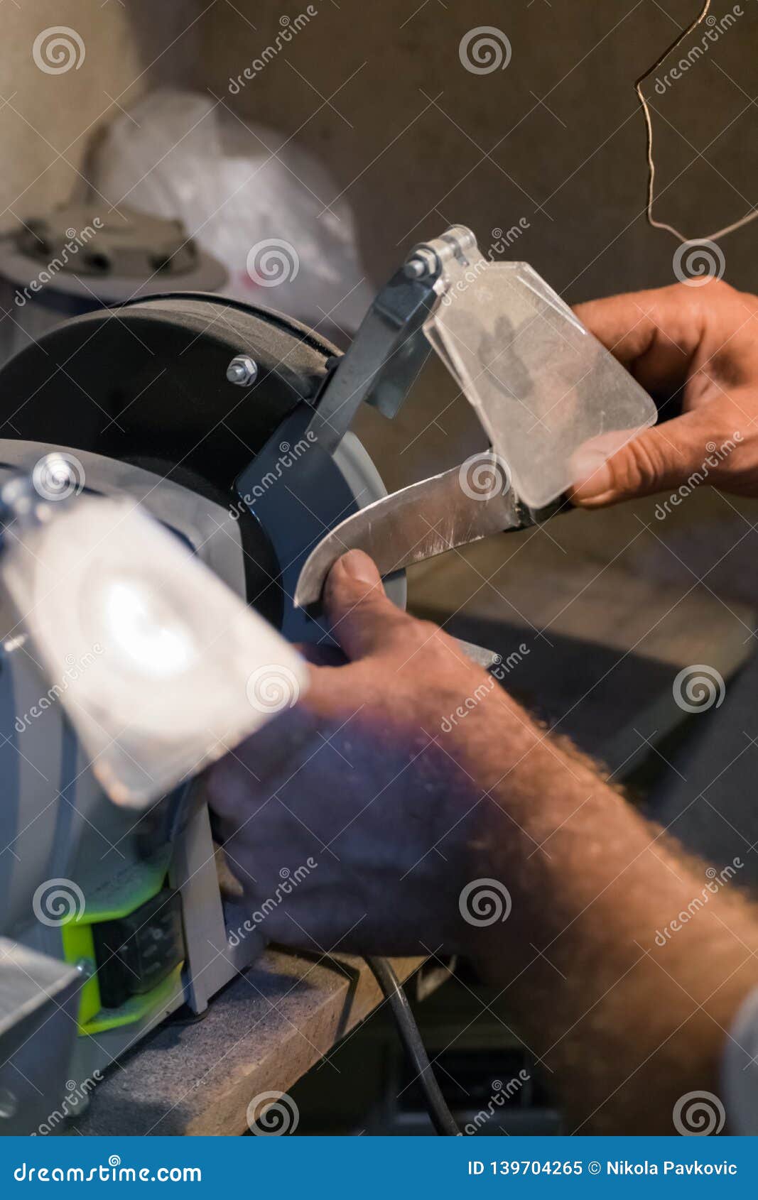 Man Sharpens a Knife on an Electric Grindstone Stock Image - Image of ...