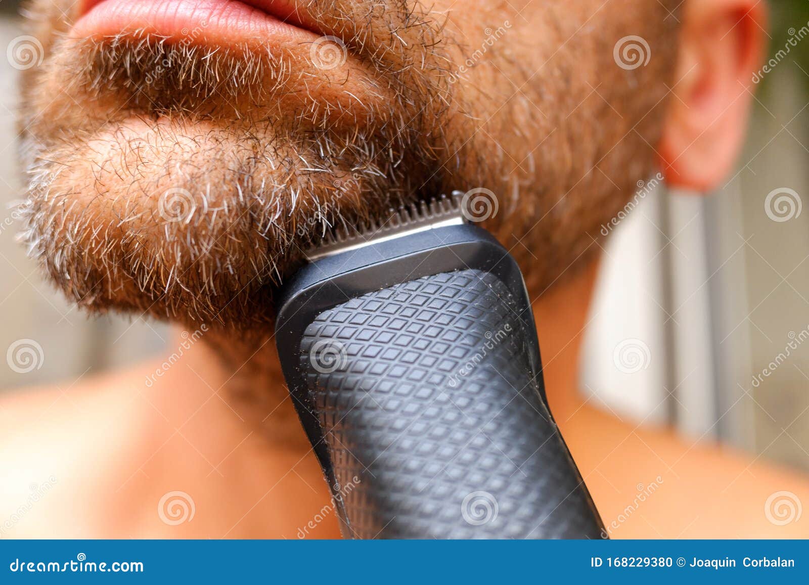 A Man Shaves His Beard Using an Electric Razor Stock Photo - Image of ...