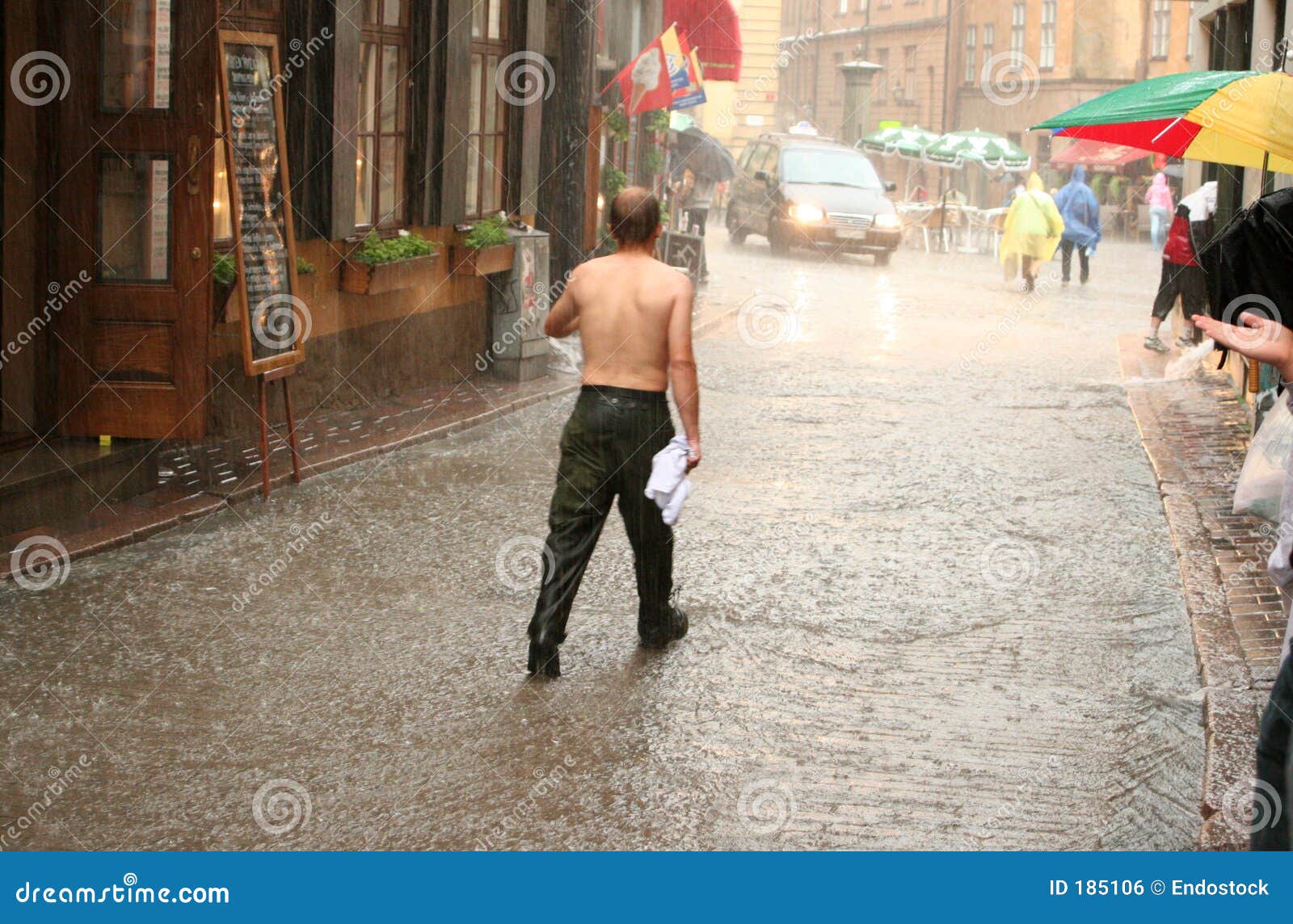 Man Walking Away In Rain
