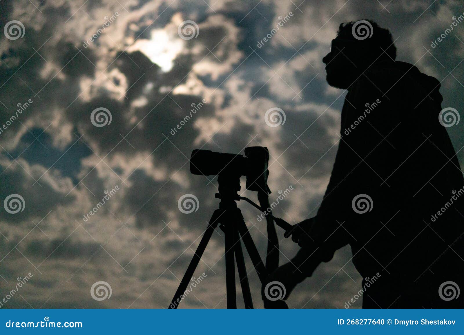 Man Shooting the Night Cloudy Sky Under Moon with a Tripod Stock Photo ...