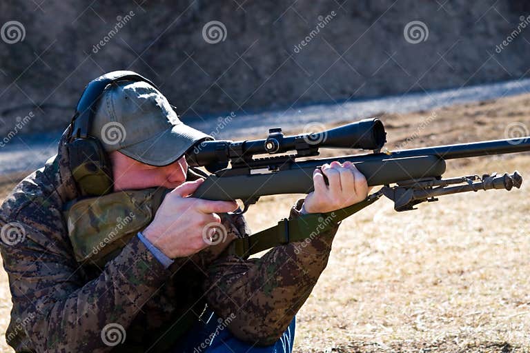 Man Shooting Rifle stock photo. Image of sighting, optic - 13060062