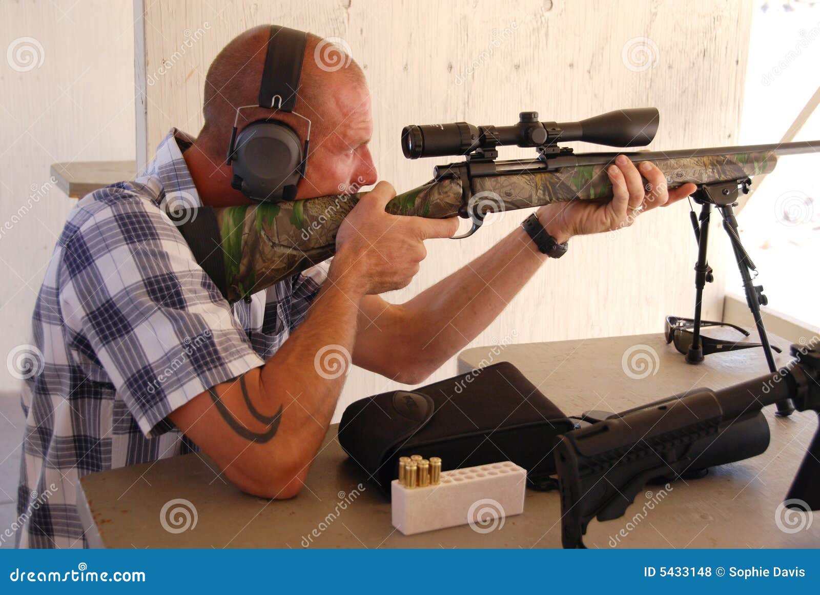 Man shooting sniper rifle. stock photo. Image of ammo - 5433148