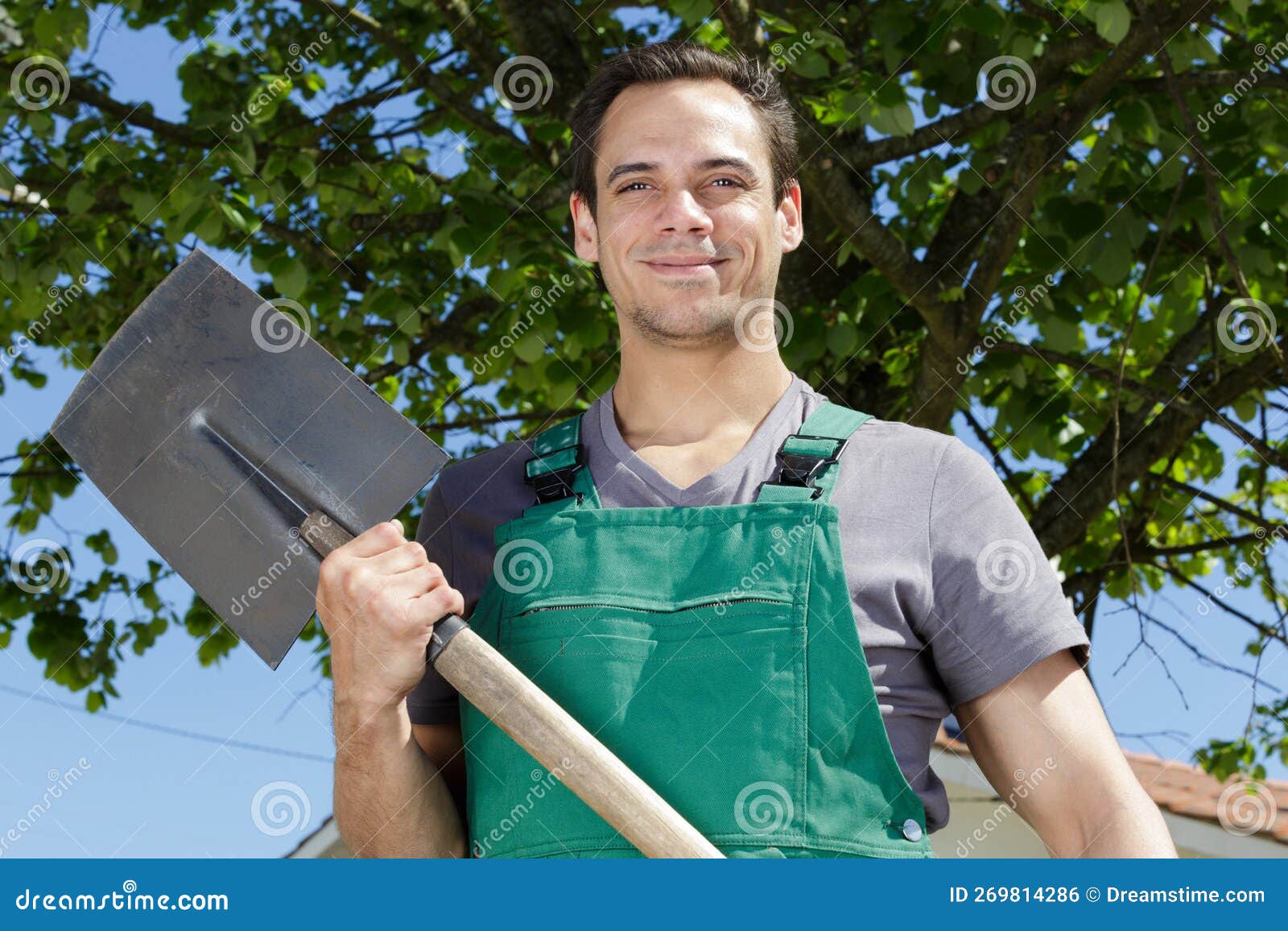 Man with shovel in garden stock photo. Image of grass - 269814286