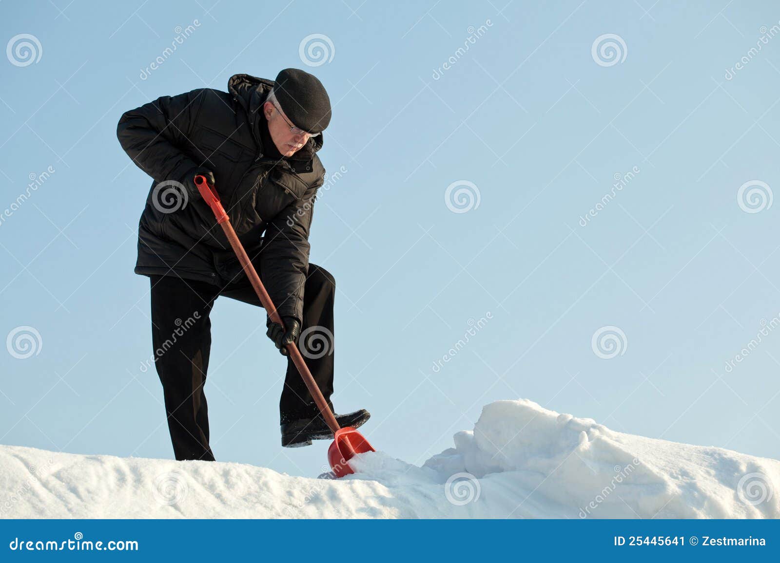 Man Shovelling Snow with a Red Shovel Stock Image - Image of caucasian ...