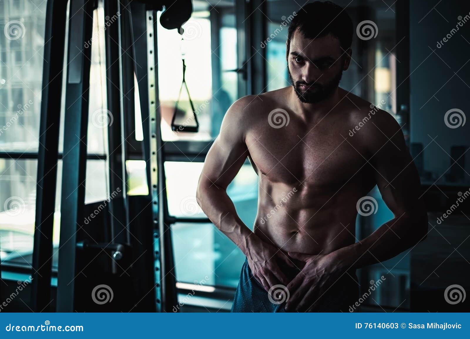 Man showing abs in the gym stock image. Image of handsome - 76140603
