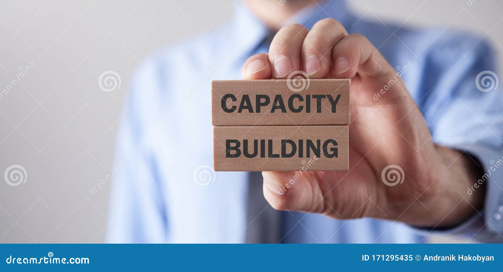 Man Showing Capacity Building Text on Wooden Blocks Stock Image - Image ...