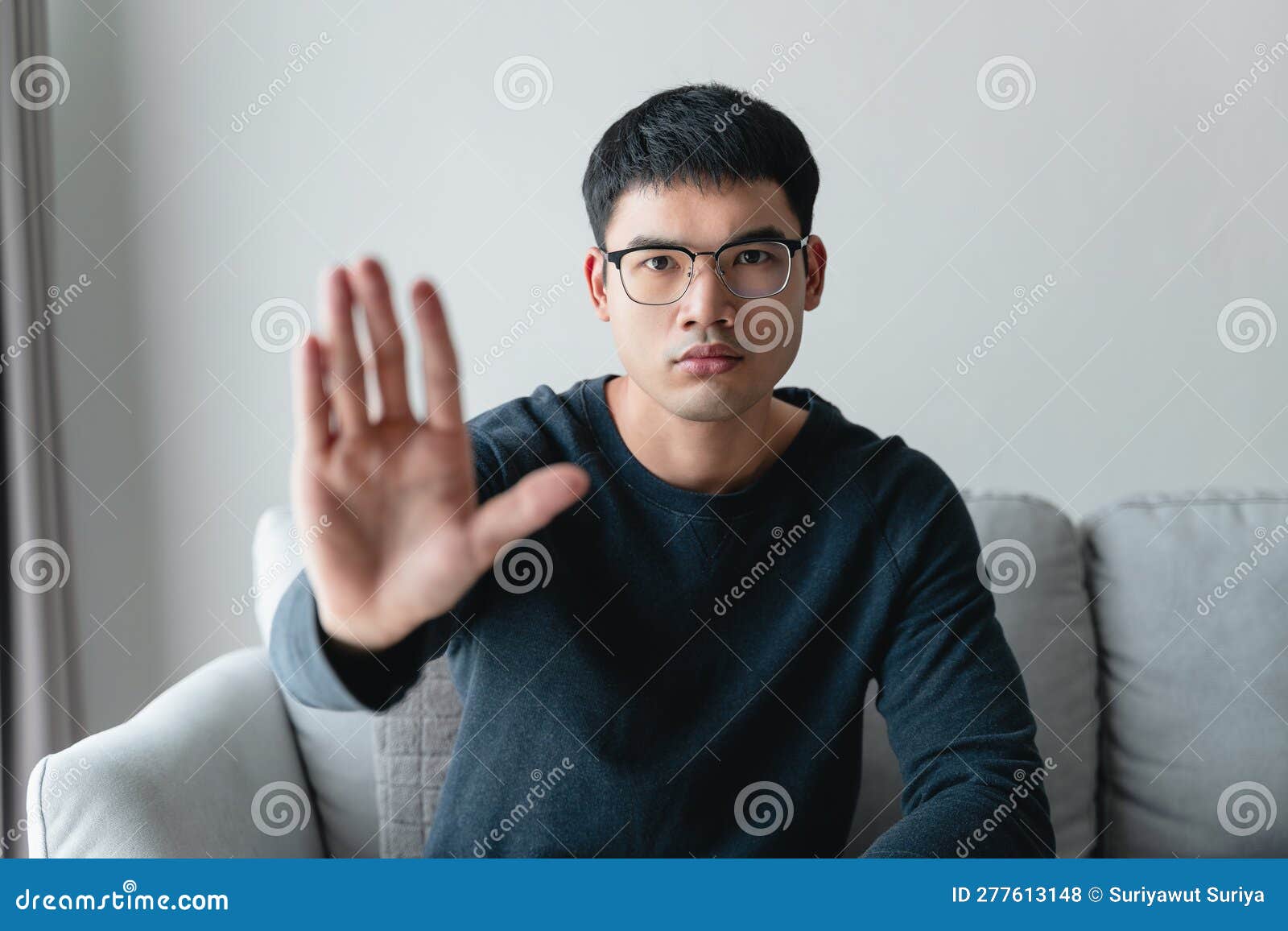 The Man Showing Hand Gesture Stop Sign Sitting on the Sofa at Home ...