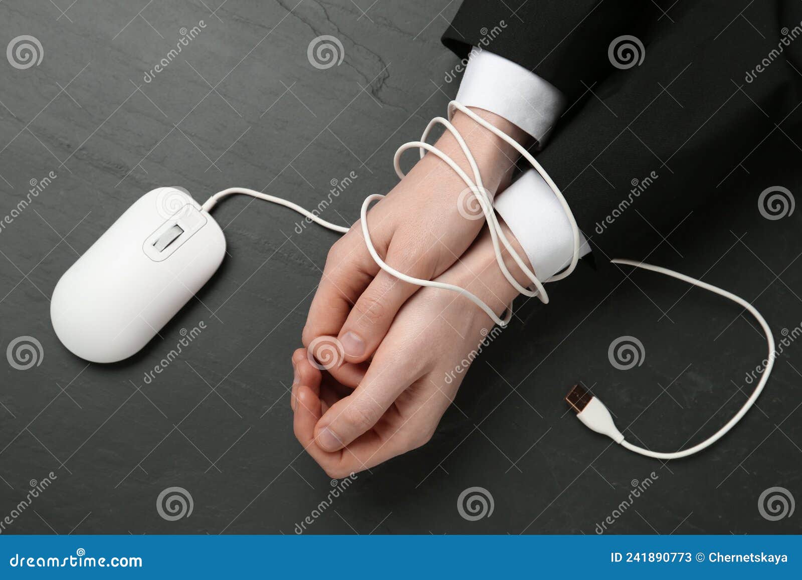 Man Showing Hands Tied with Computer Mouse Cable at Black Table, Top ...