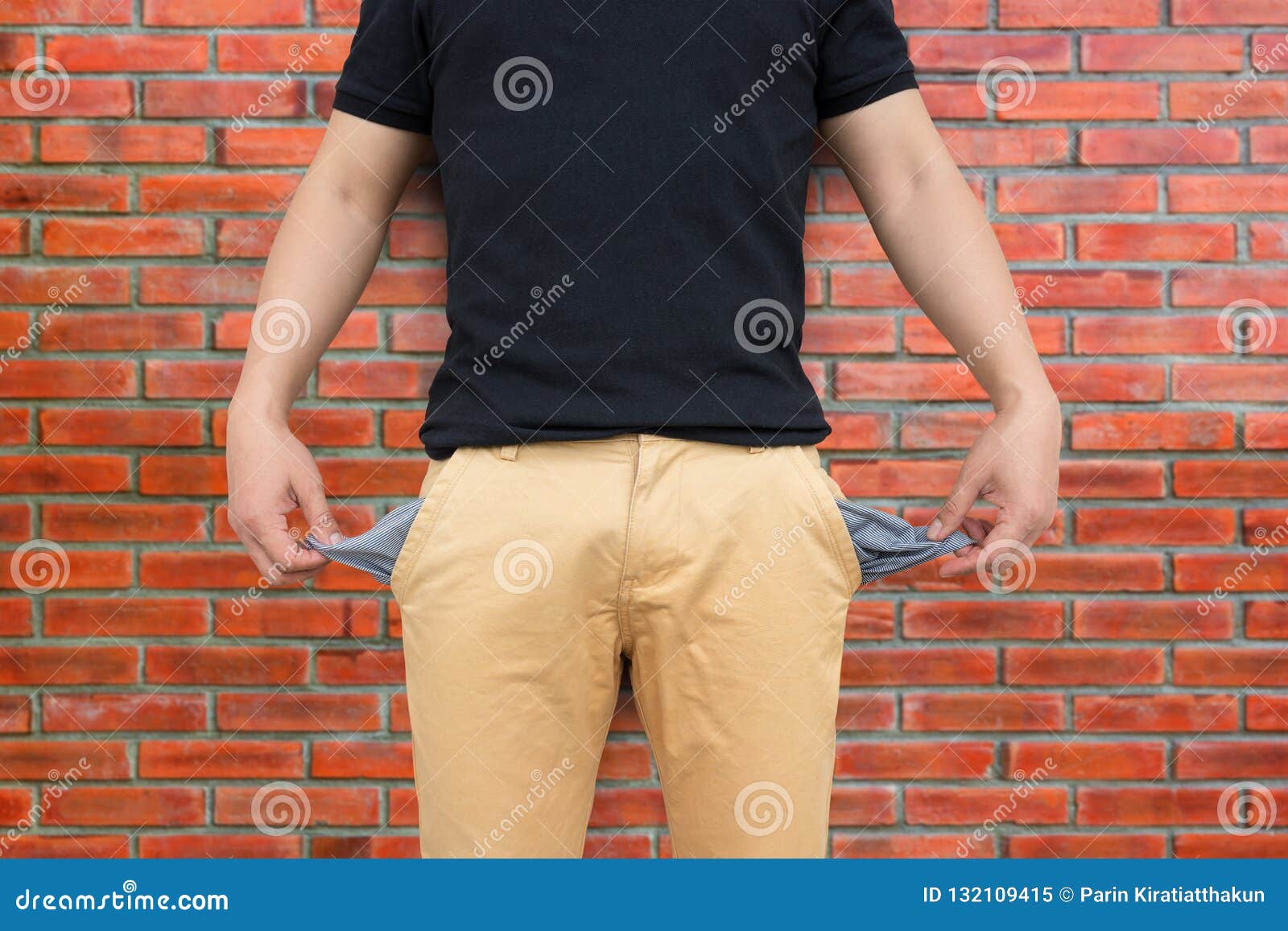 Man Showing His Empty Pockets on Brick Wall Stock Image - Image of ...