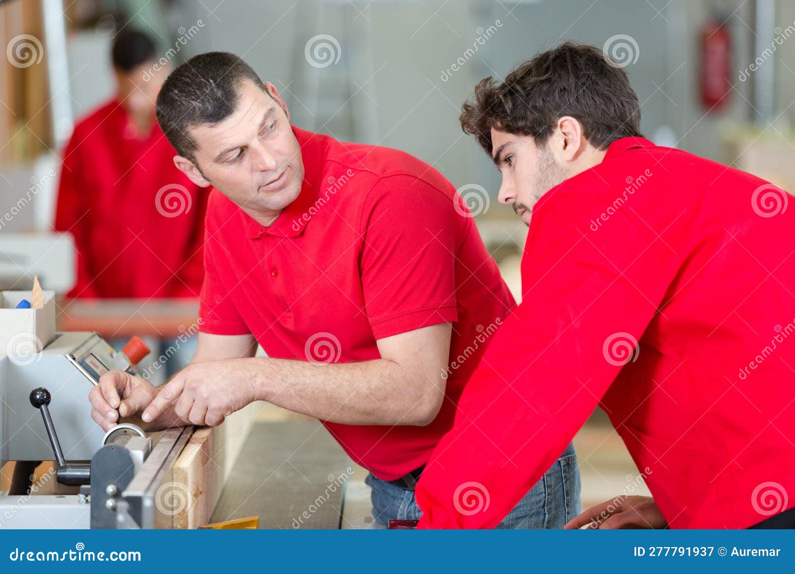 Man Showing Trainee How To Set Up Machine in Workshop Stock Image ...