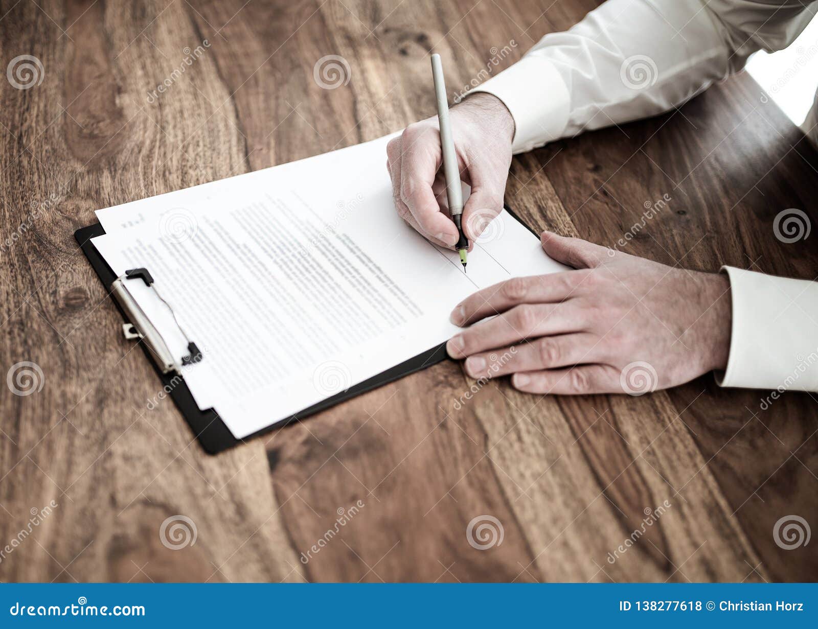 Man Signing Contract or Document at Wooden Desk Stock Photo - Image of ...