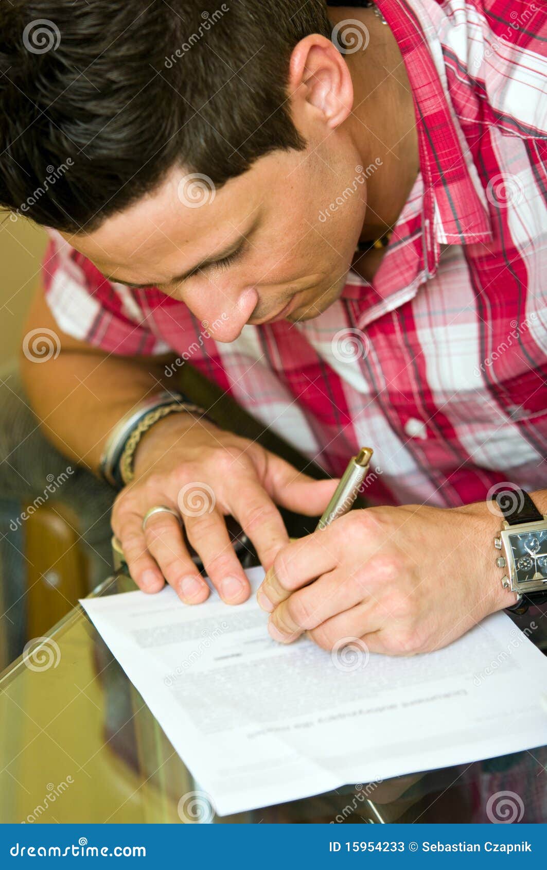 Man signing documents stock image. Image of home, young - 15954233