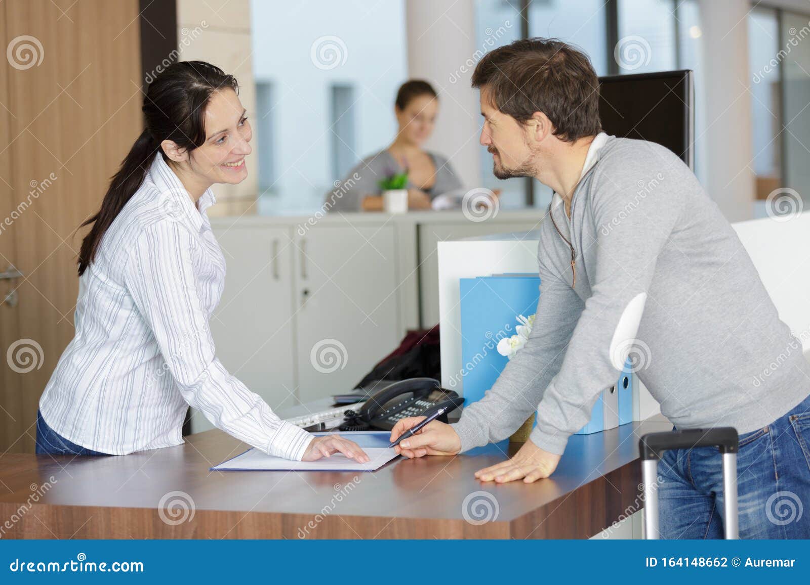 Man Signing in at Reception Desk Stock Photo - Image of reception ...