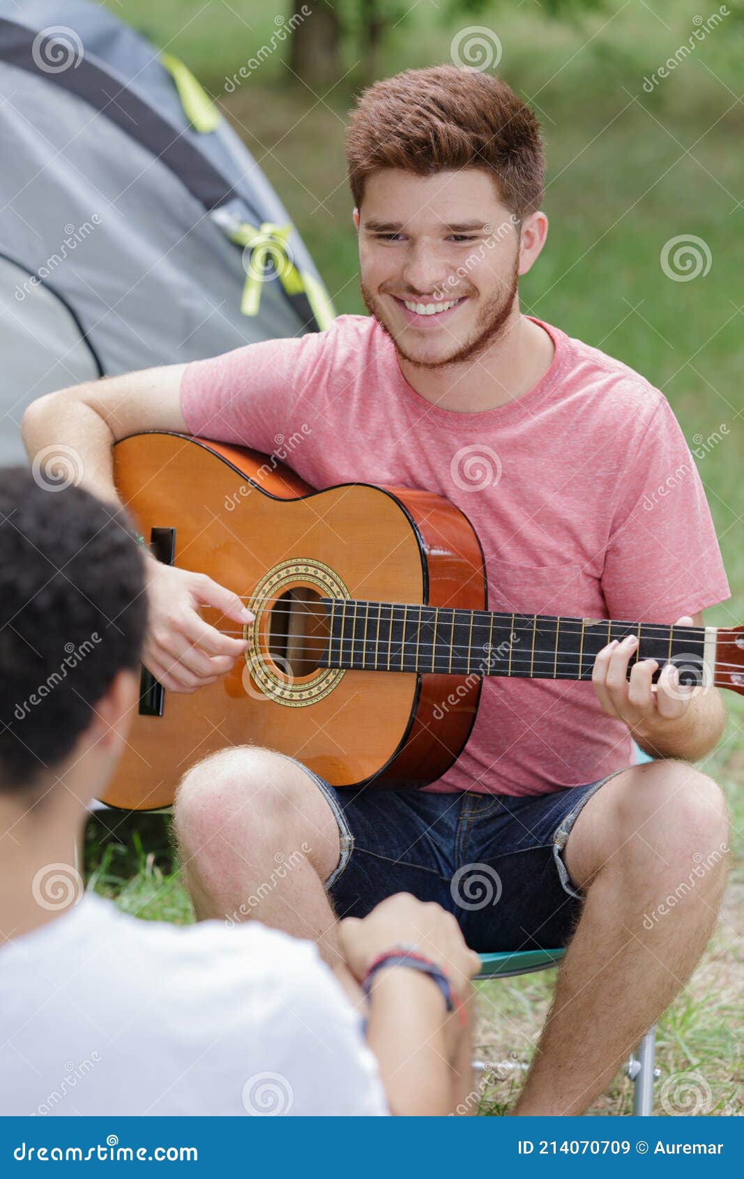 Man Singing and Playing Guitar Outside Tent Stock Image - Image of tent ...